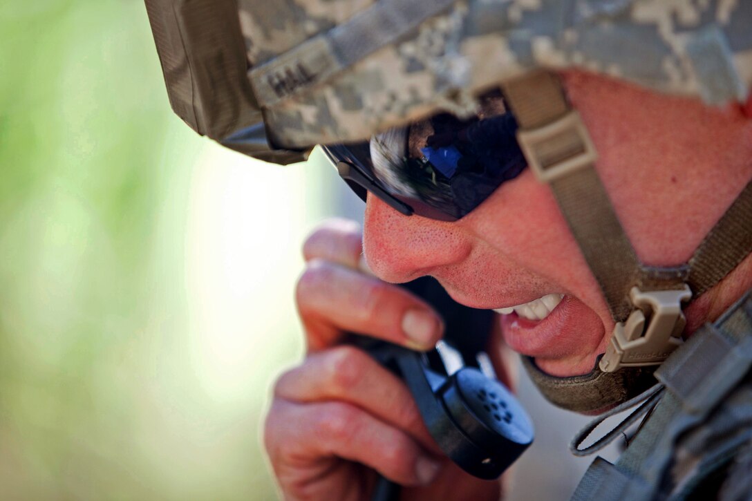 Army 1st Lt. Steven Hail radios in coordinates for a casualty ...