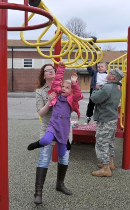 Army Staff Sgt. Joshua and Army Pfc. Christy Garlick play with their ...
