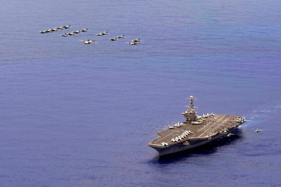 Aircraft from the John C. Stennis Carrier Strike Group fly in formation during a demonstration ...