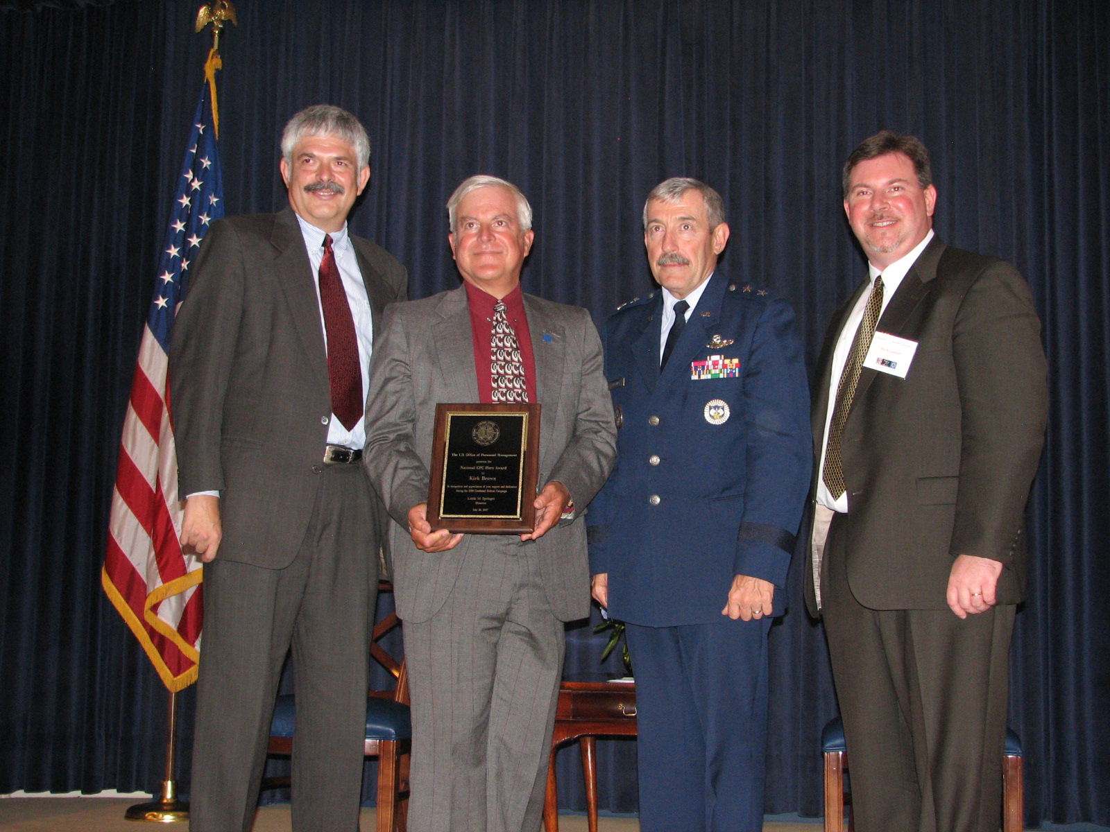 Kirk Brown (second from left) takes time for a photo after receiving ...