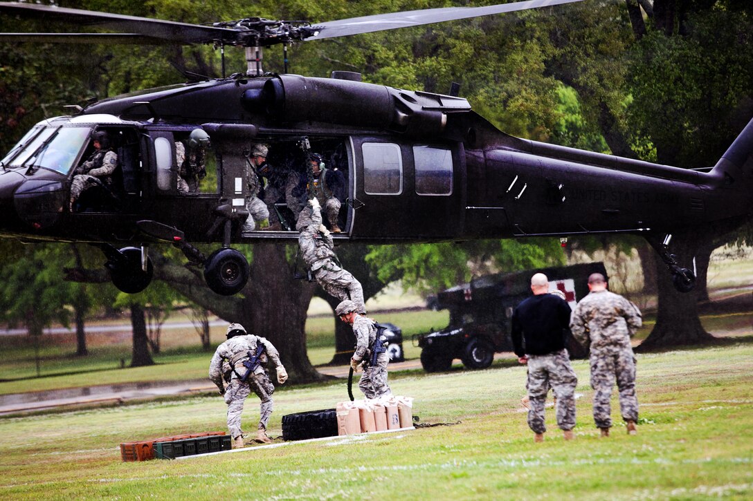 Soldiers use the fast rope insertion-extraction system from a UH-60 ...