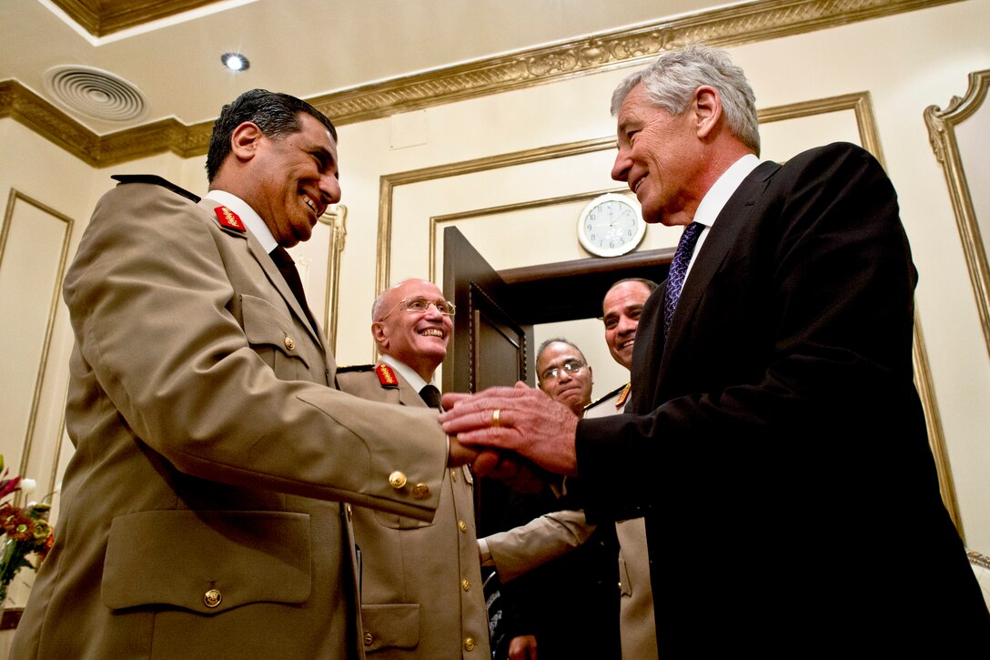 U.S. Defense Secretary Chuck Hagel, right, shakes hands with Egyptian ...