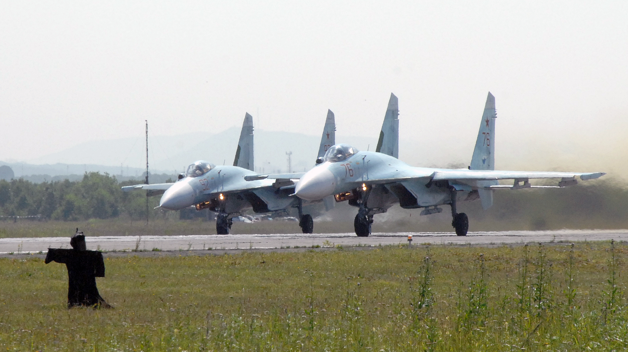 A pair of Russian Federation Air Force SU-27 Flanker fighters take off ...