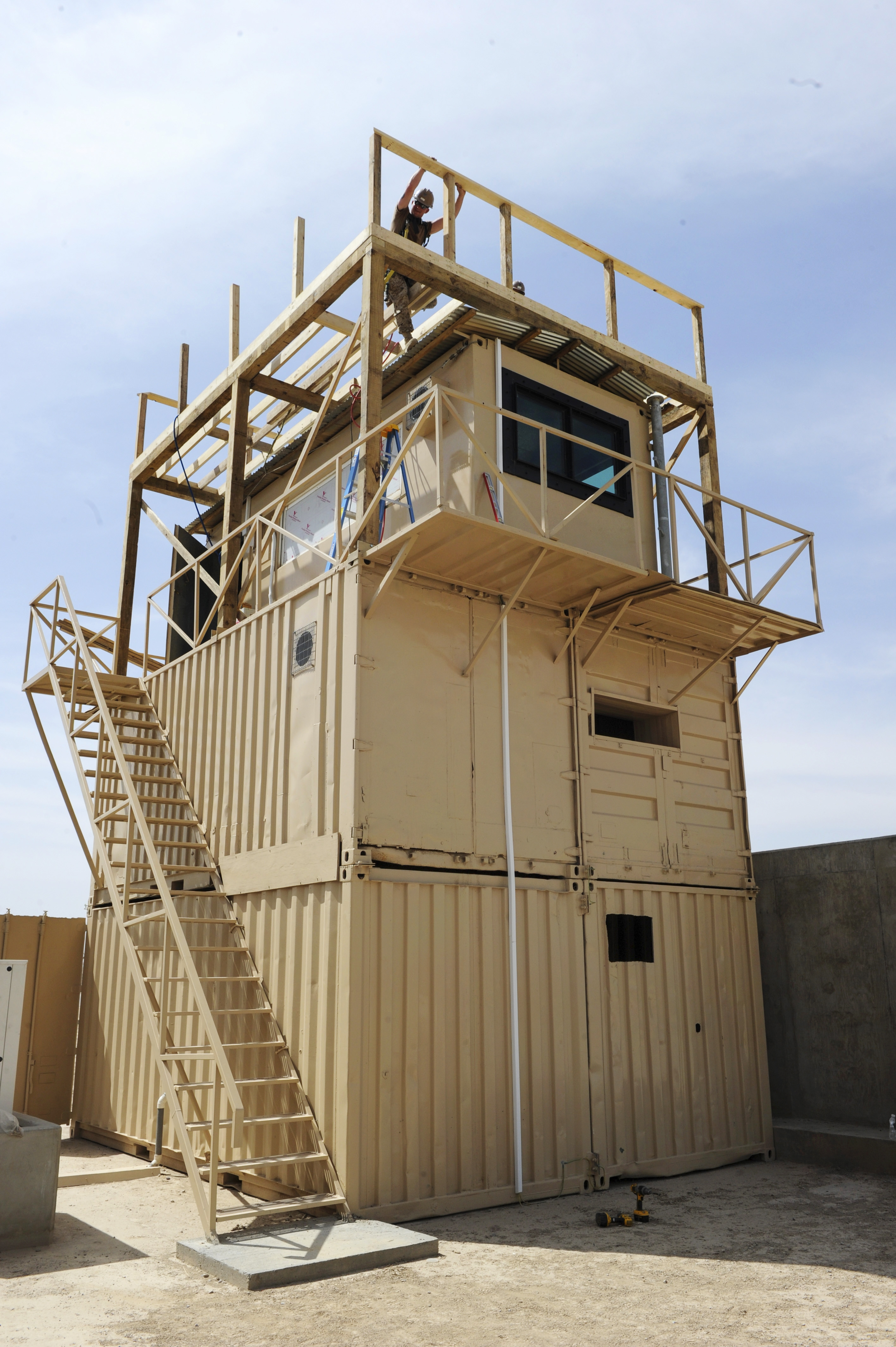 U.S. Navy Seabees work to complete a tower for the launch and recovery ...