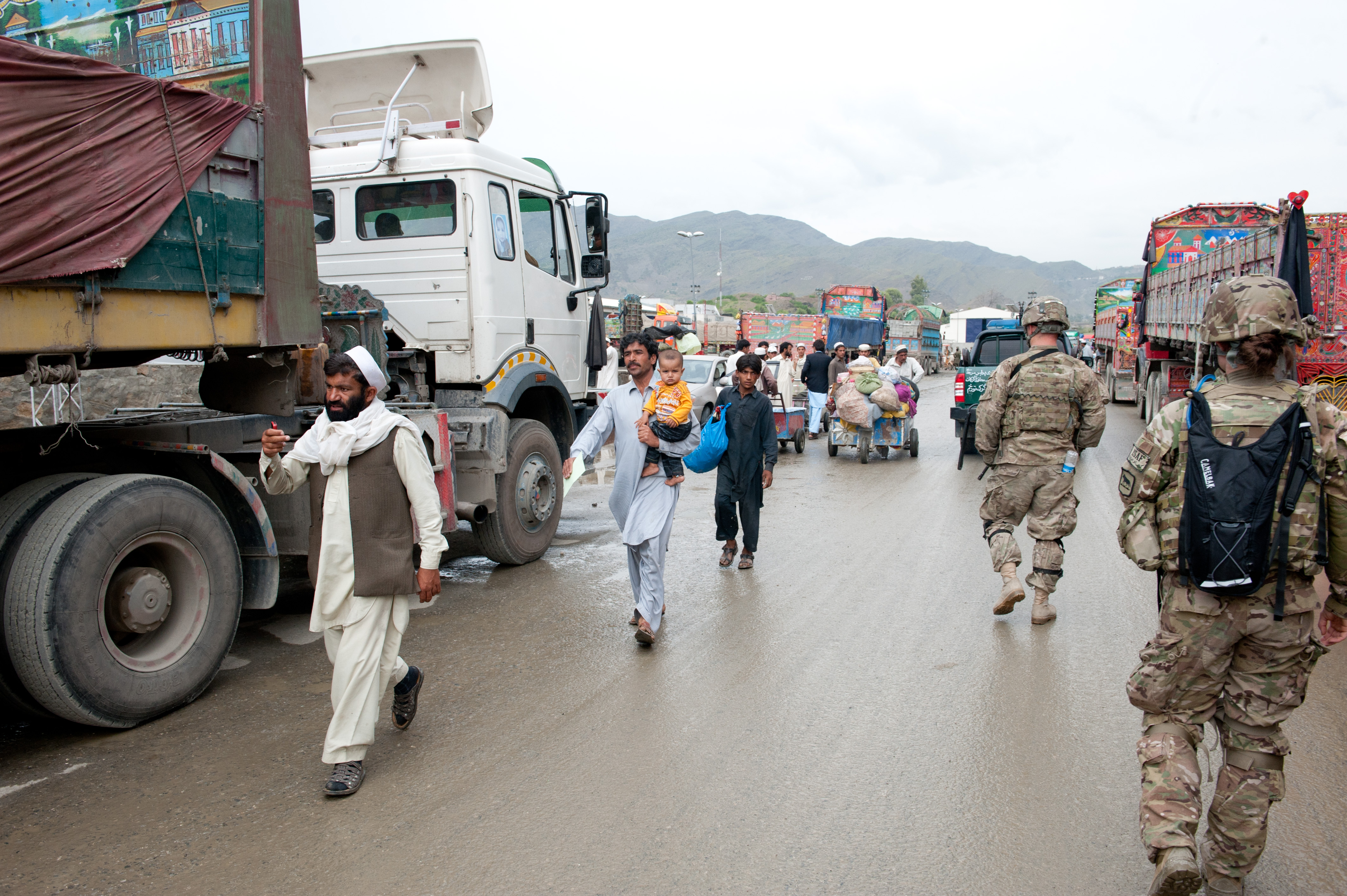 U.S. soldiers patrol near traffic from Pakistan at the Torkham Gate ...