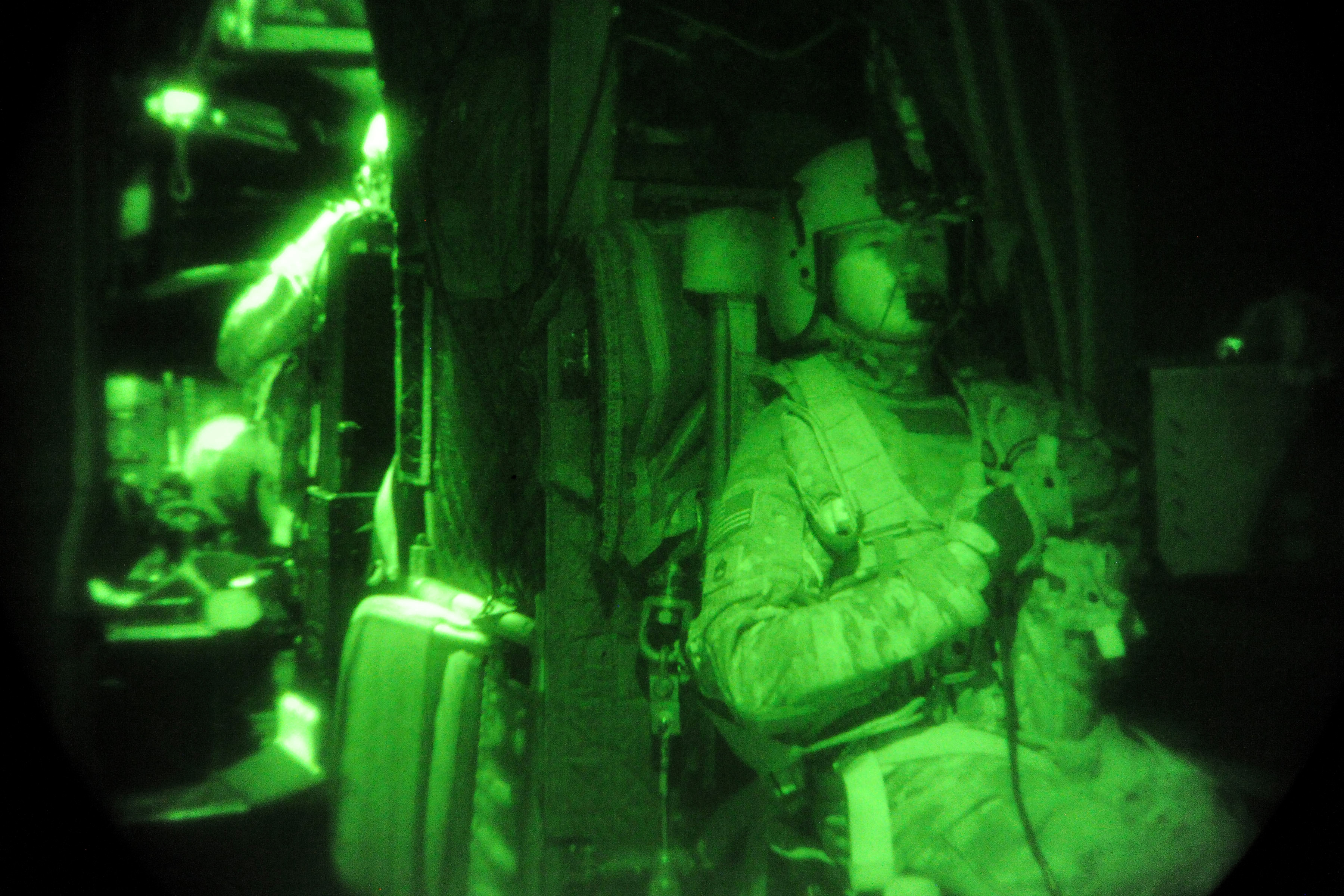 As seen through a night-vision device, U.S. Army Sgt. 1st Class Eric ...
