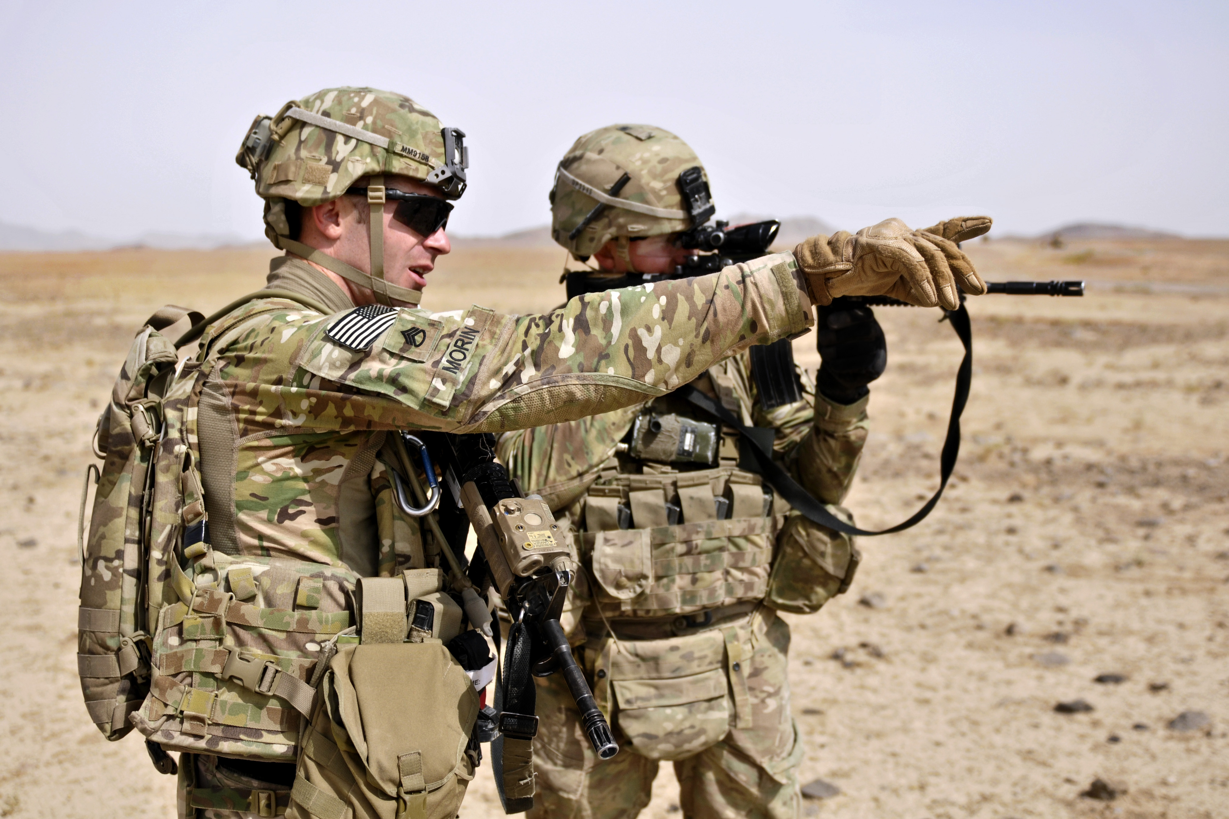 U.S. Army Staff Sgt. Matthew Morin, left, points as U.S. Army 2nd Lt ...