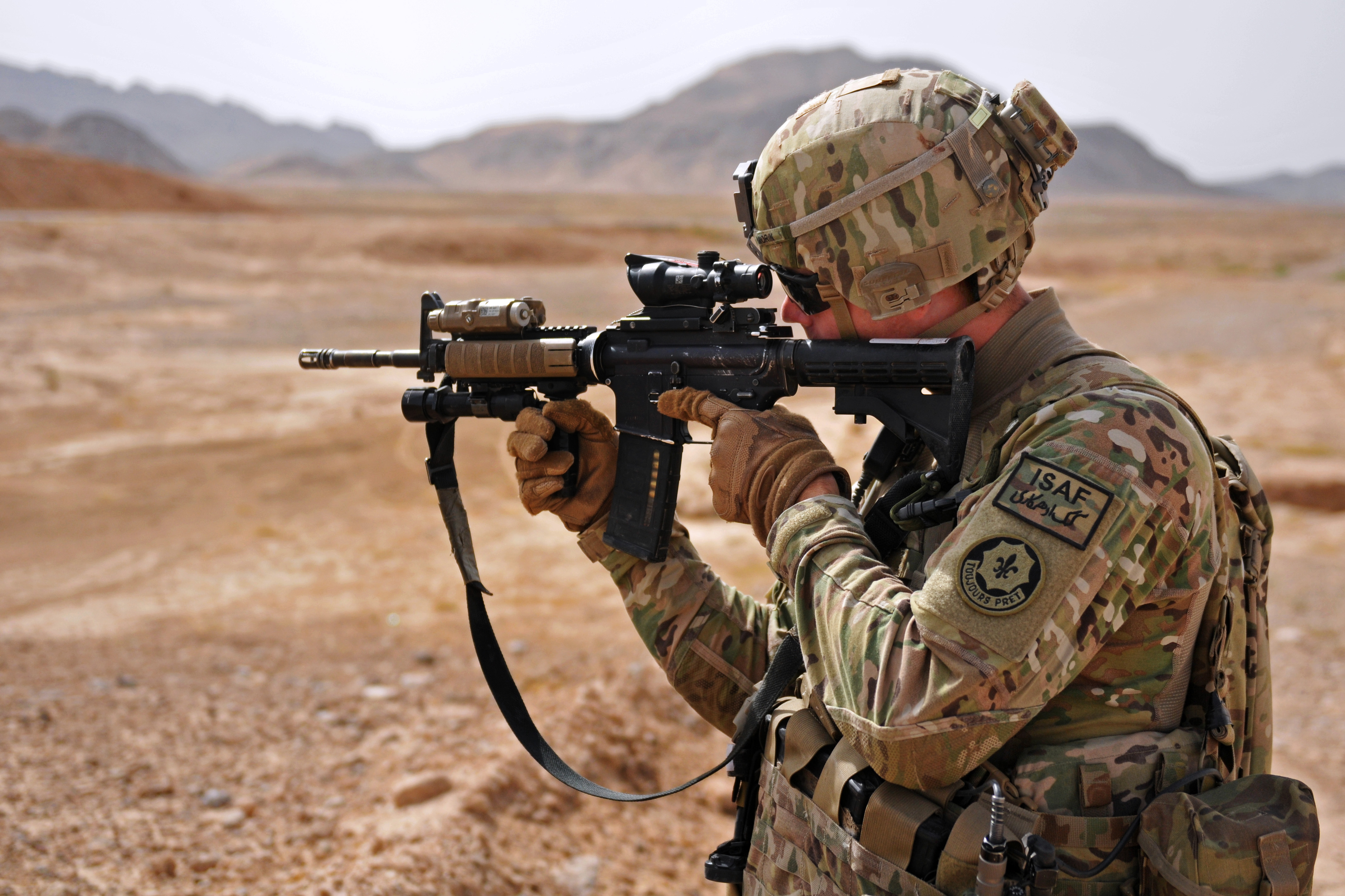 U.S. Army Staff Sgt. Matthew Morin scans the area and a culvert using ...