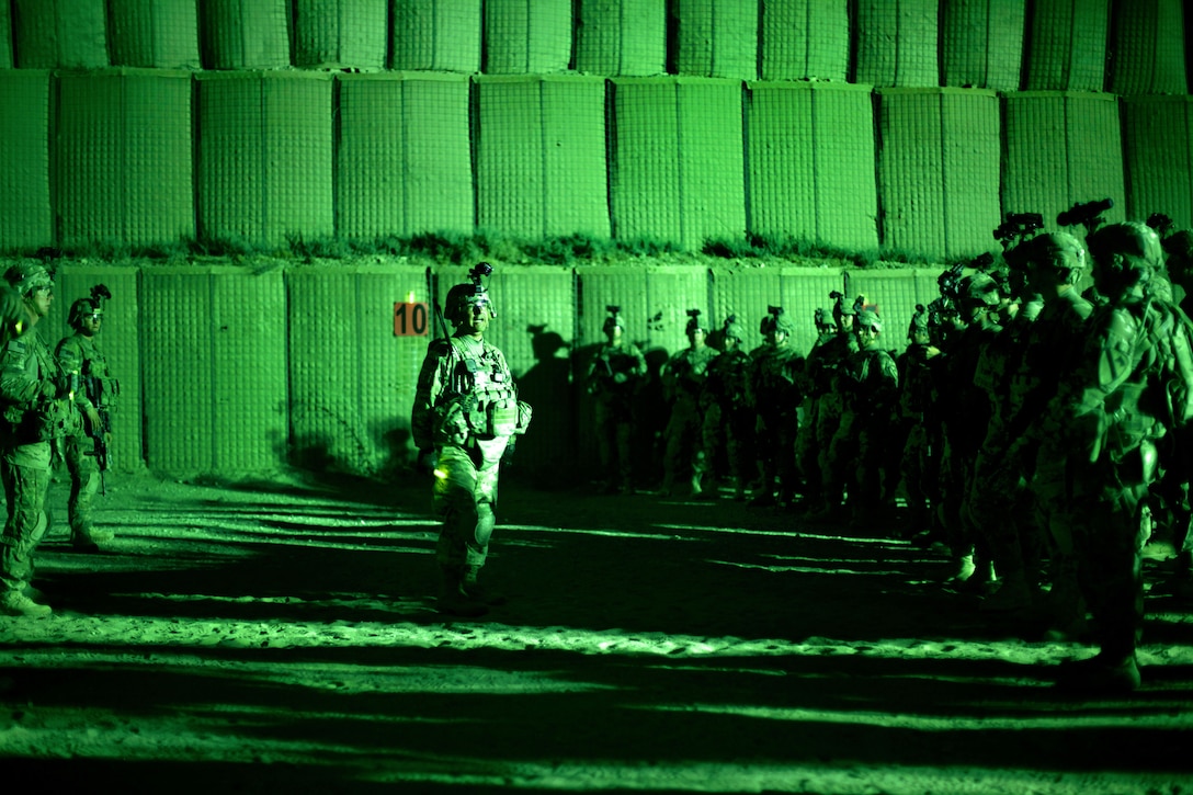As seen through a night-vision device, U.S. soldiers receive a mission ...