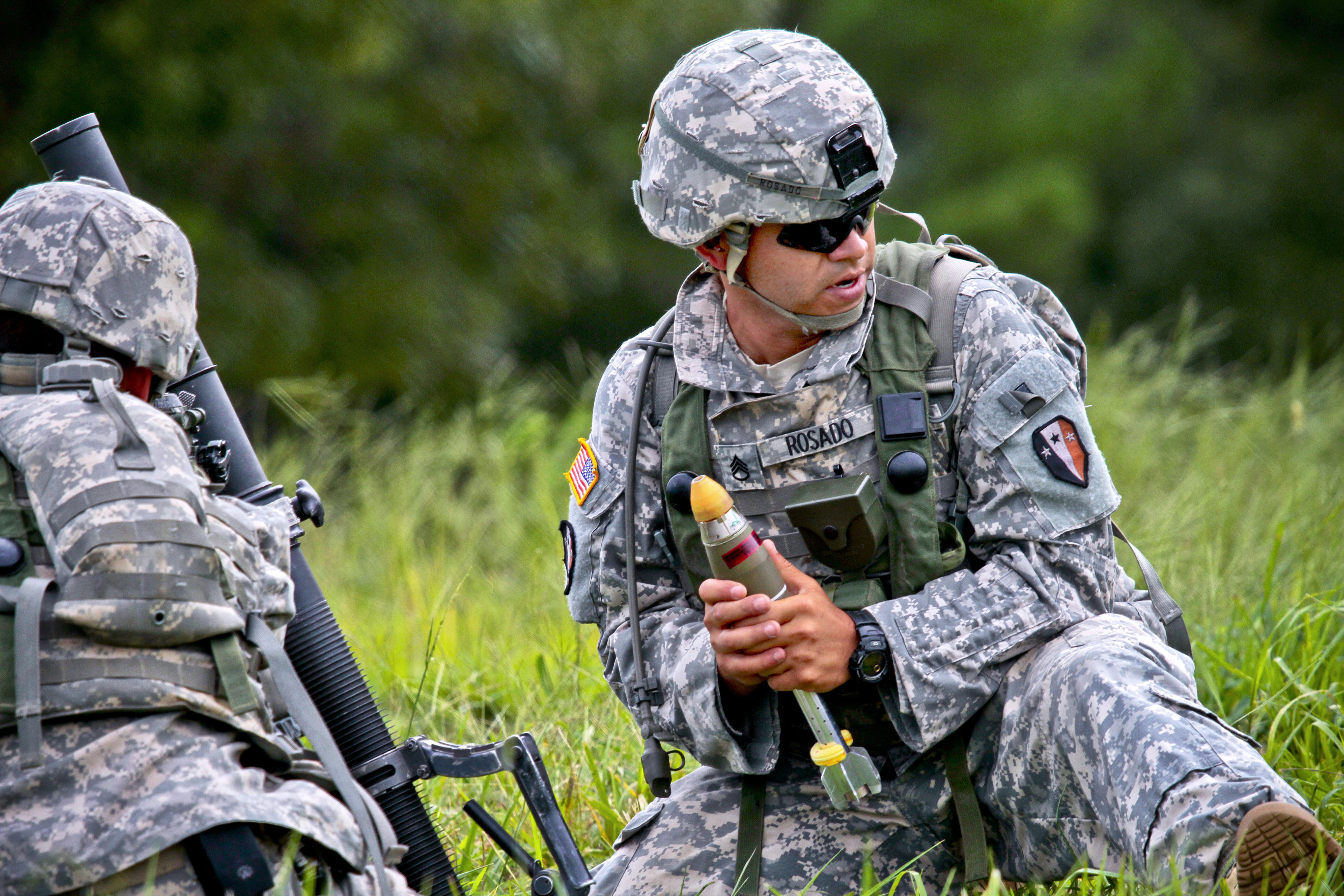 A soldier prepares to load a mortar round before firing it during a ...