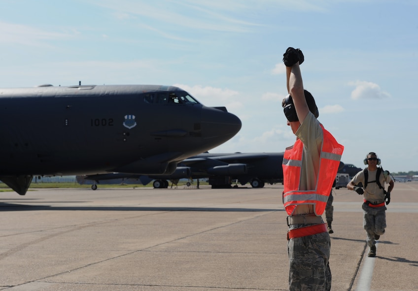 Maintainers marshal aircrew to the sky