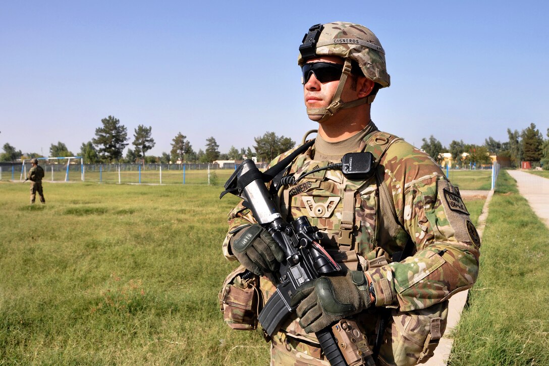 U.S. Army Sgt. Federico Cisneros provides security as members of ...
