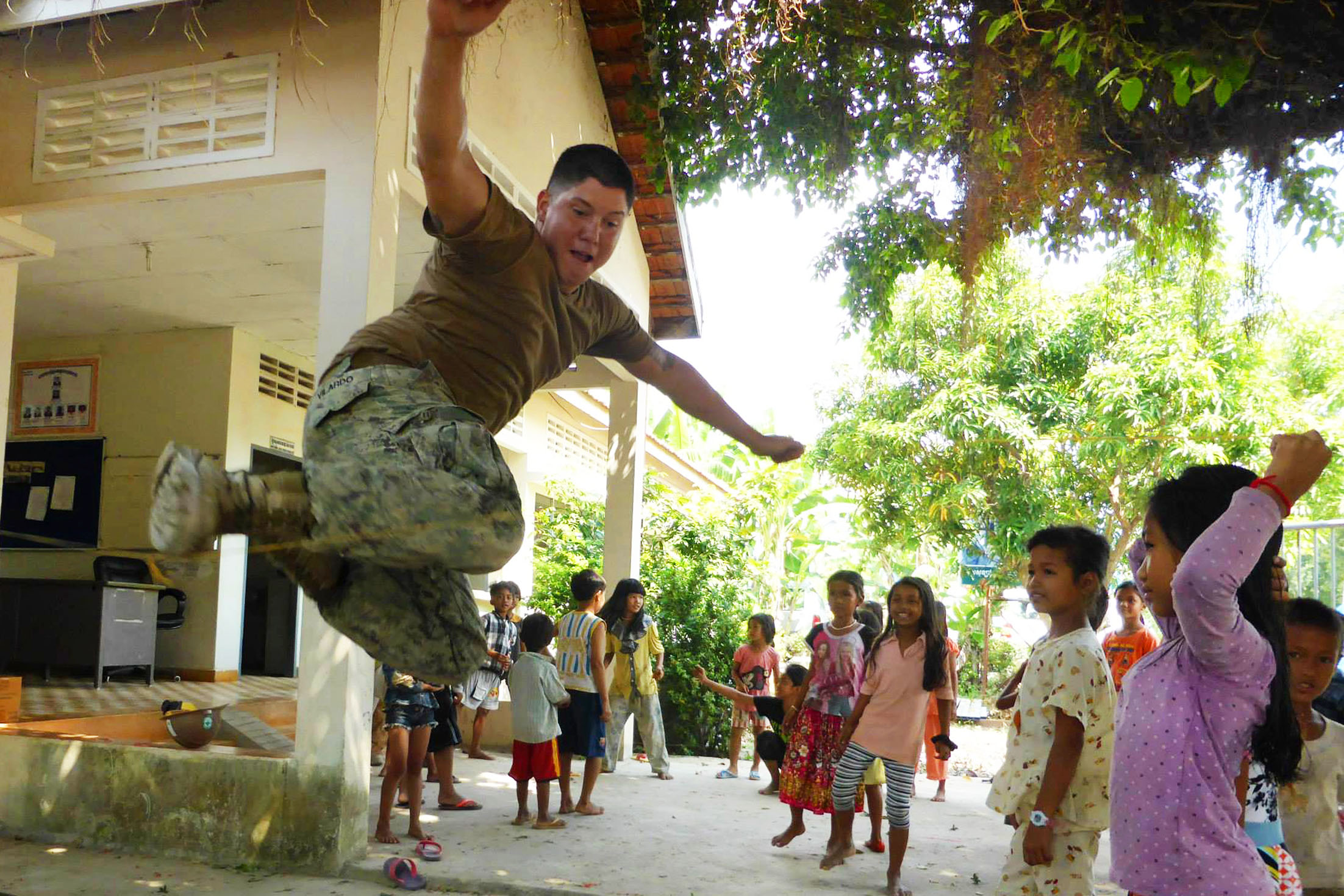 U.S. Navy Seaman Michael Vilardo plays with local children near the ...