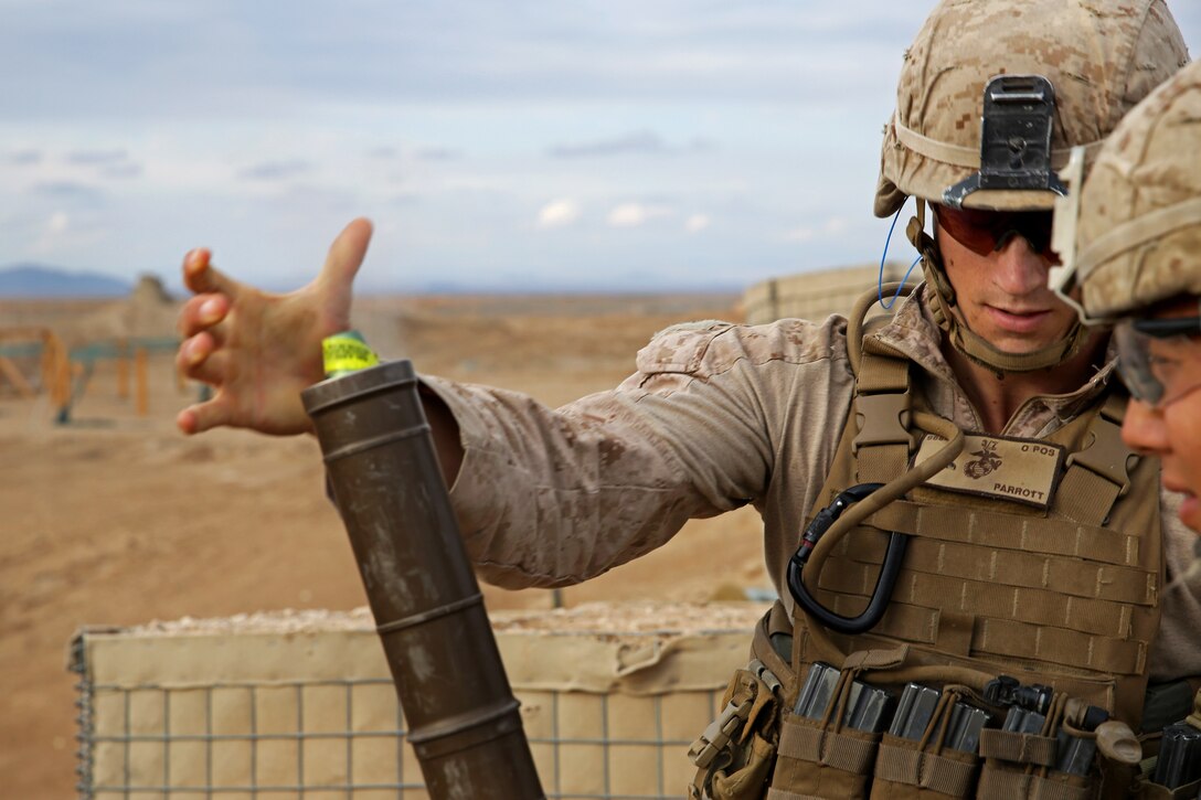 U.S. Marine Corps Lance Cpl. Dale Parrott fires a 60mm mortar during ...