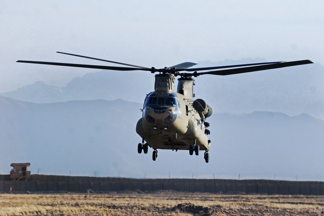 A U.S. Army CH-47F Chinook helicopter hovers while conducting a ...
