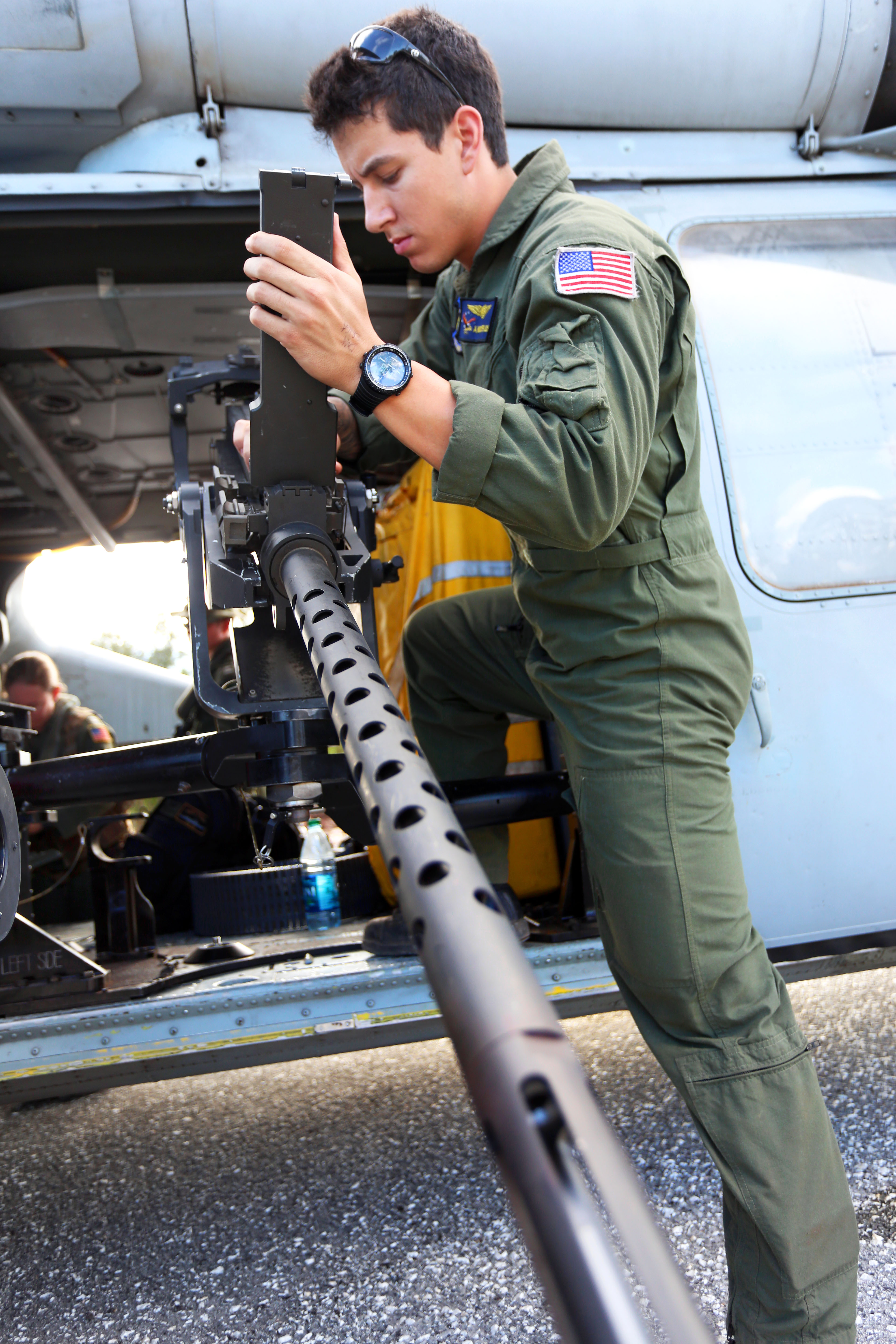 U.S. Navy Petty Officer 2nd Class Jeremy A. Cieplich checks a GAU-21/A ...