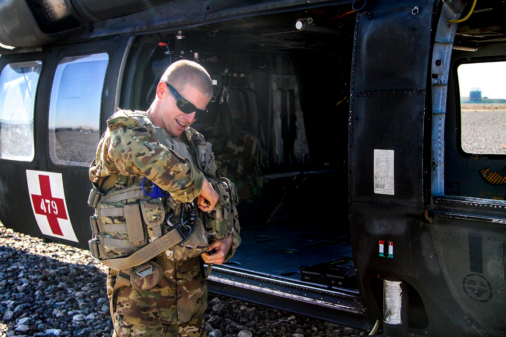 U.S. Army Sgt. Ryan Moore secures his flight gear on Shindand Air Base ...