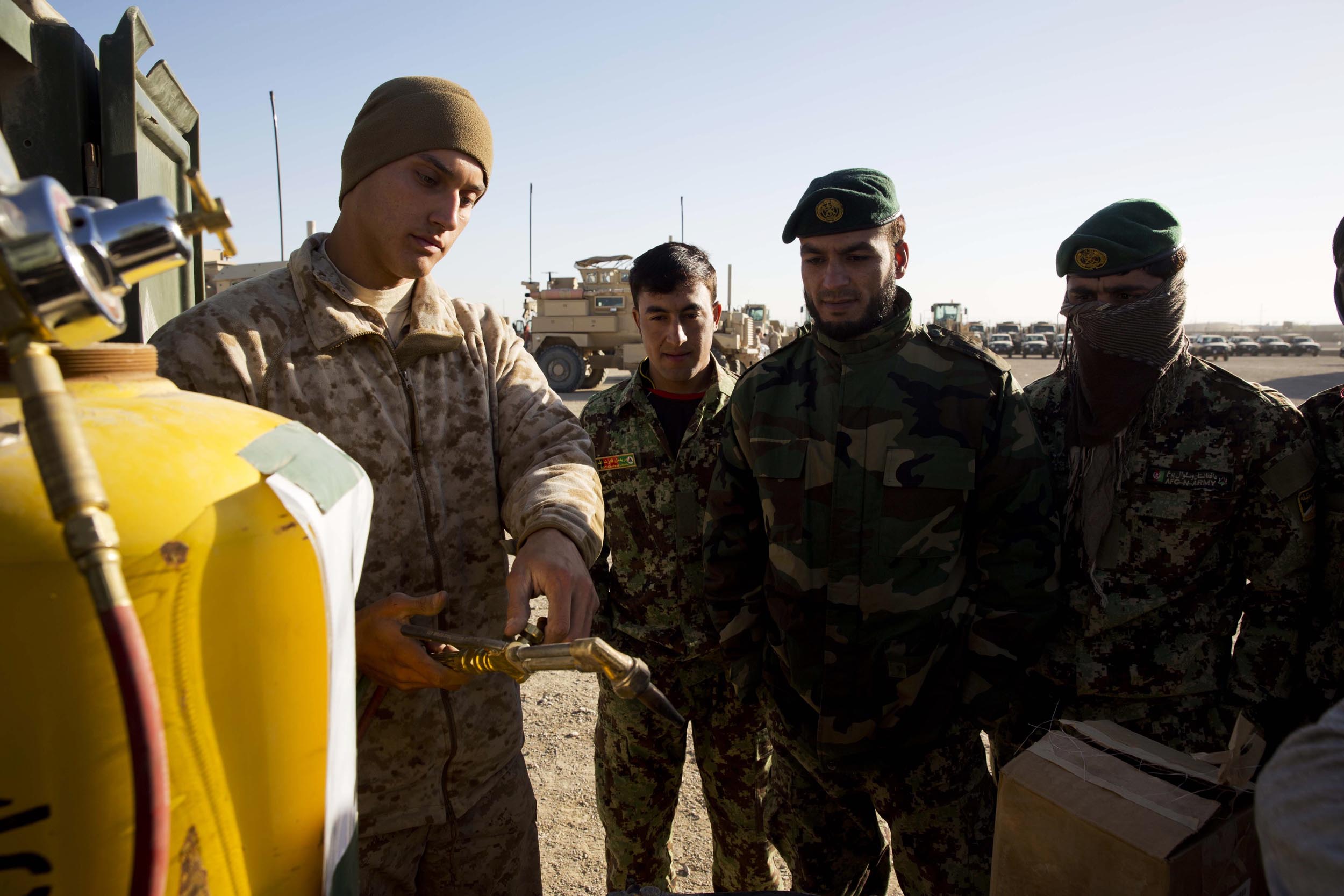 U.S. Marine Corps Luis Gonzales demonstrates how to use a welding torch ...