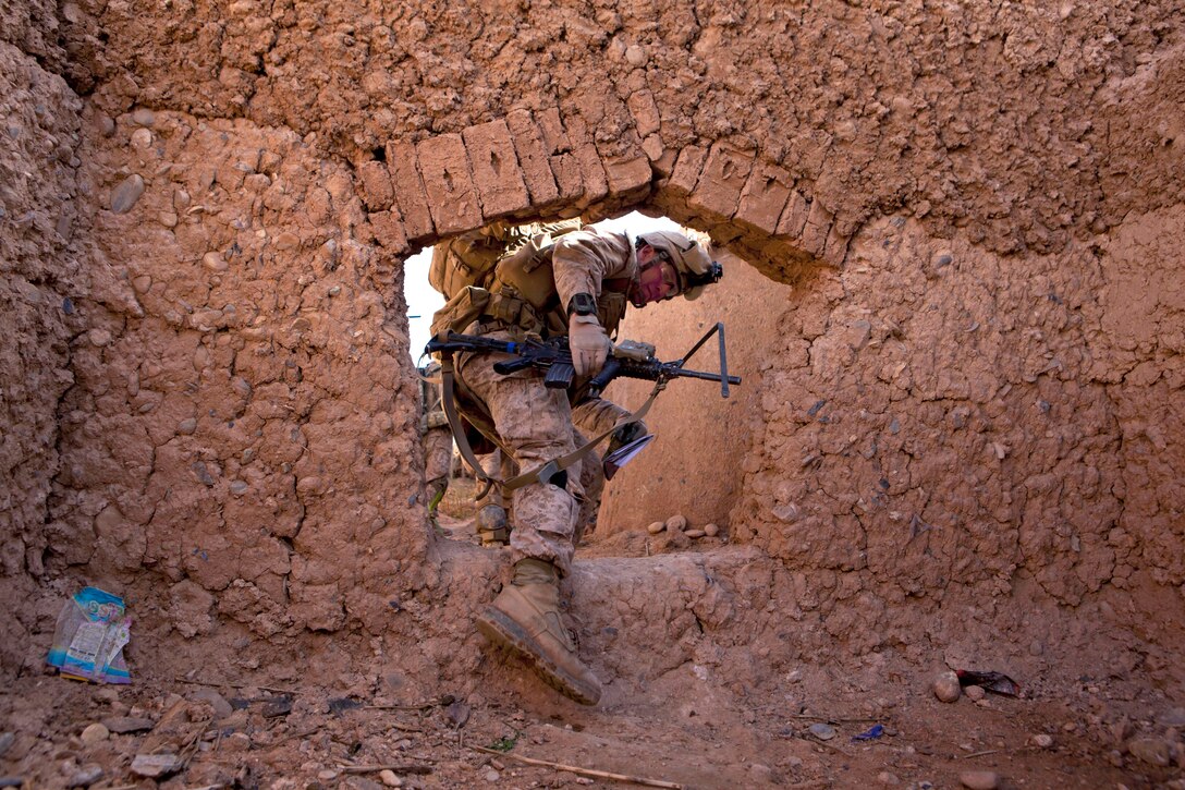 U.S. Marine Corps 2nd Lt. James Salka steps through a compound ...