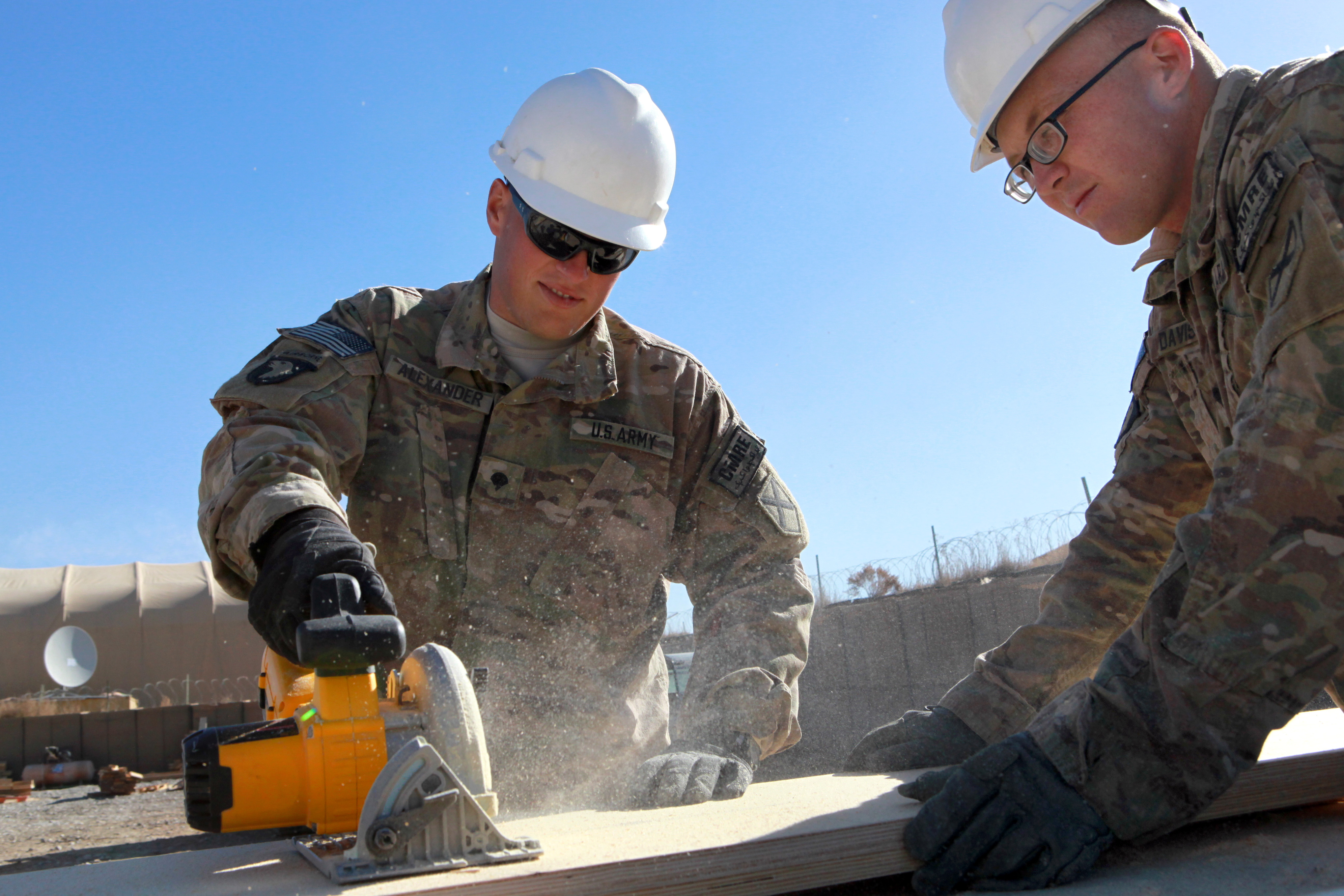 U.S. Army Spcs. Joseph Alexander, left, and Jeremy Davis cut floor ...