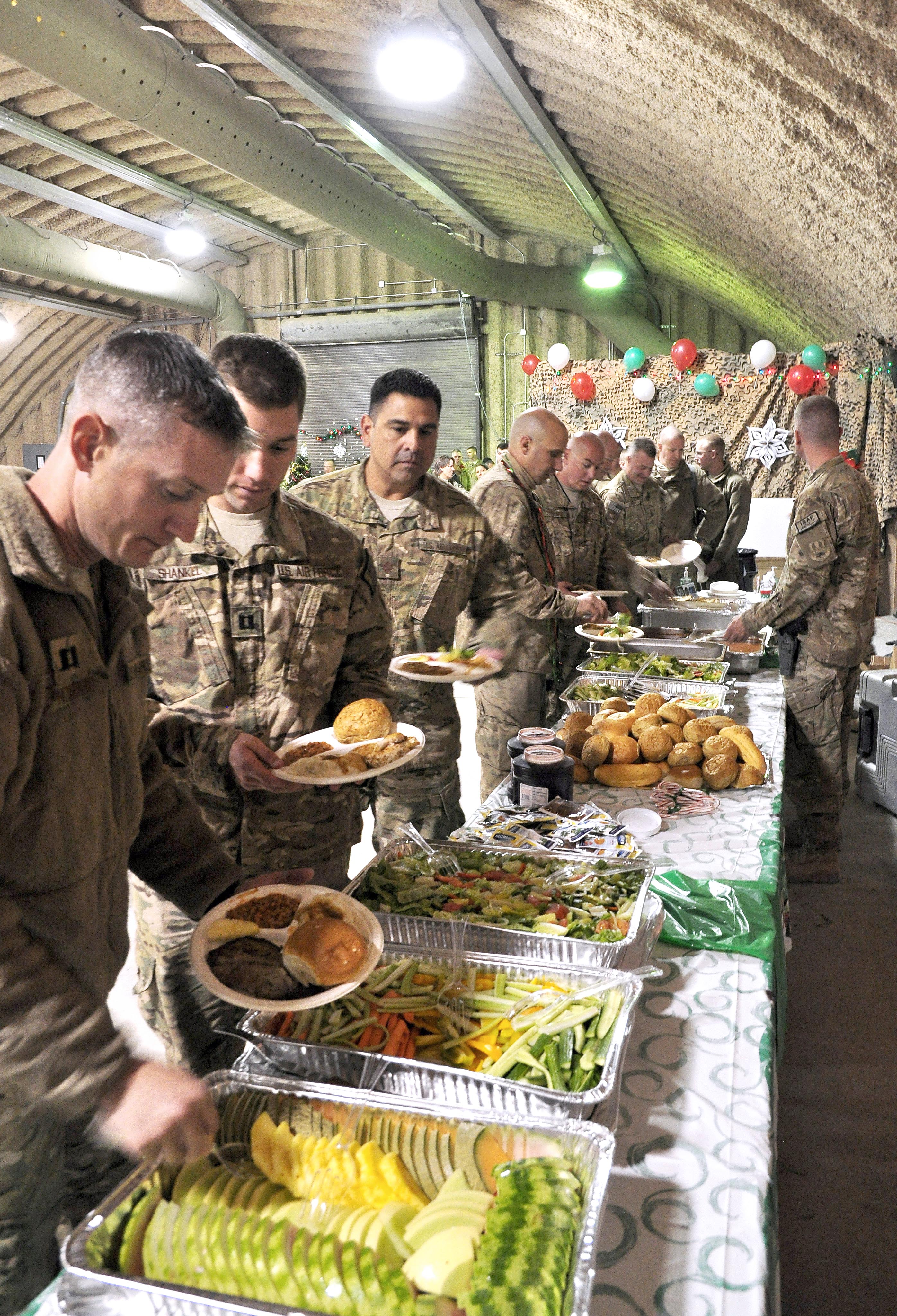 U.S. service members work through the food line during the Christmas ...