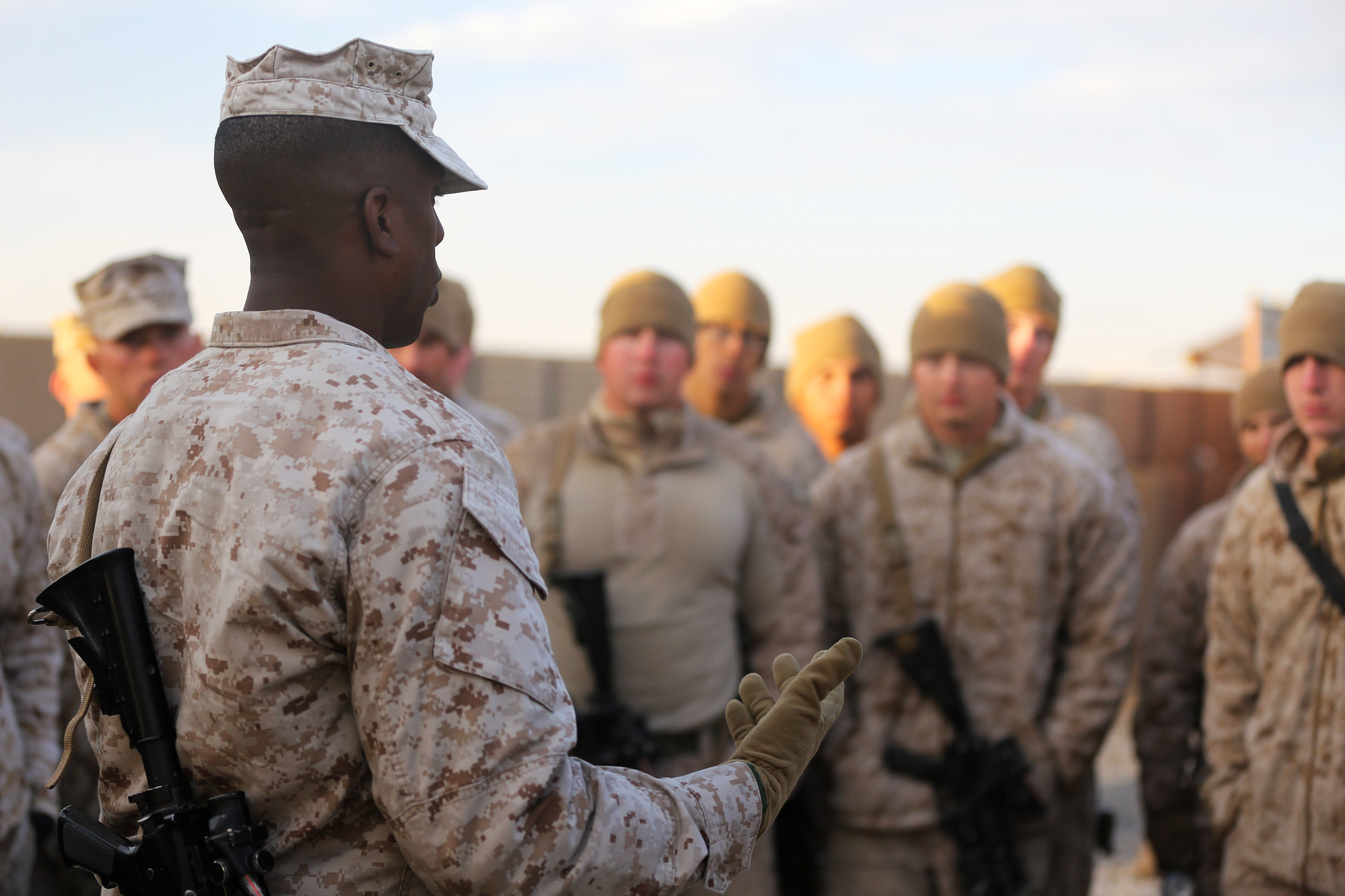 U.S. Marine Corps Capt. Gardea Christian, left foreground, briefs ...