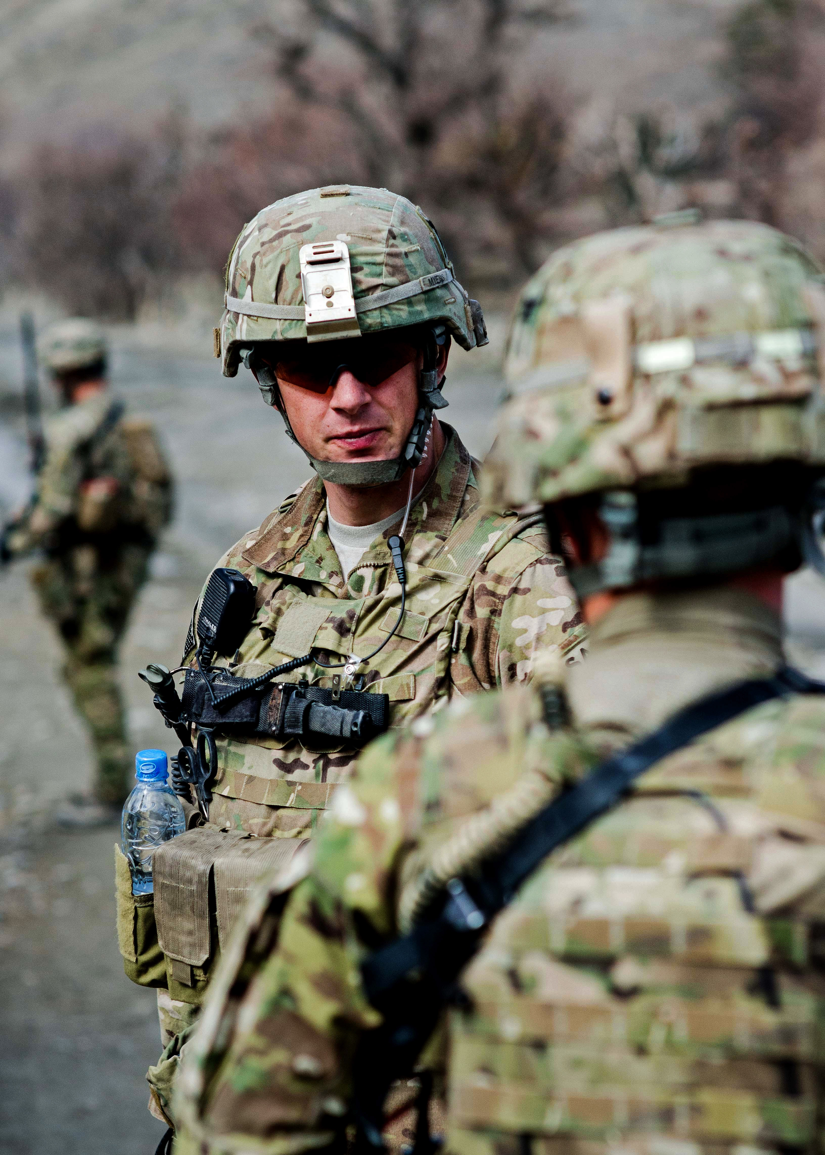 U.S. Army Sgt. Isaiah Myers, center, talks with his team as they pull ...