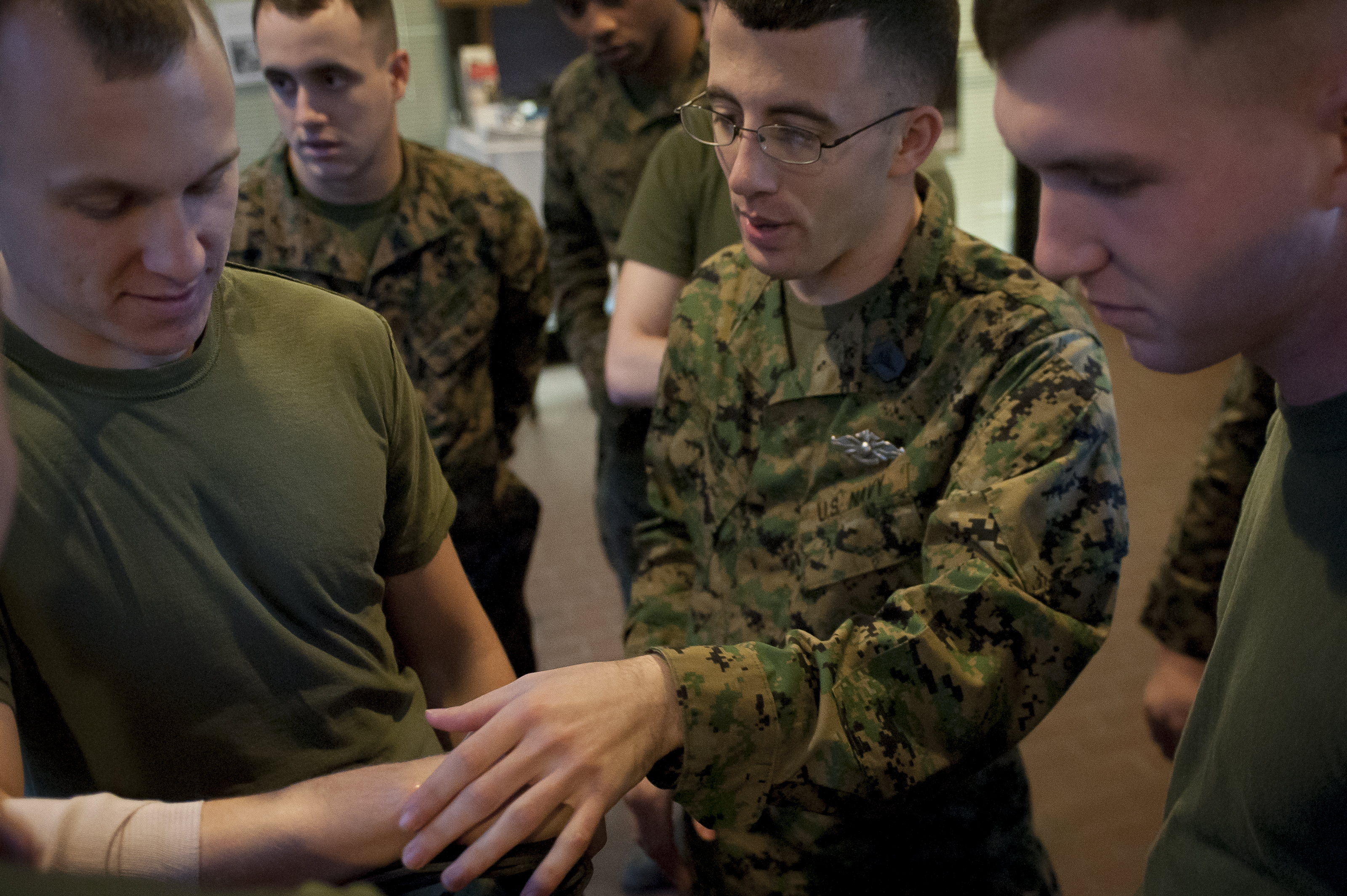 Navy Petty Officer 2nd Class Michael Pappas explains to Marines how to ...