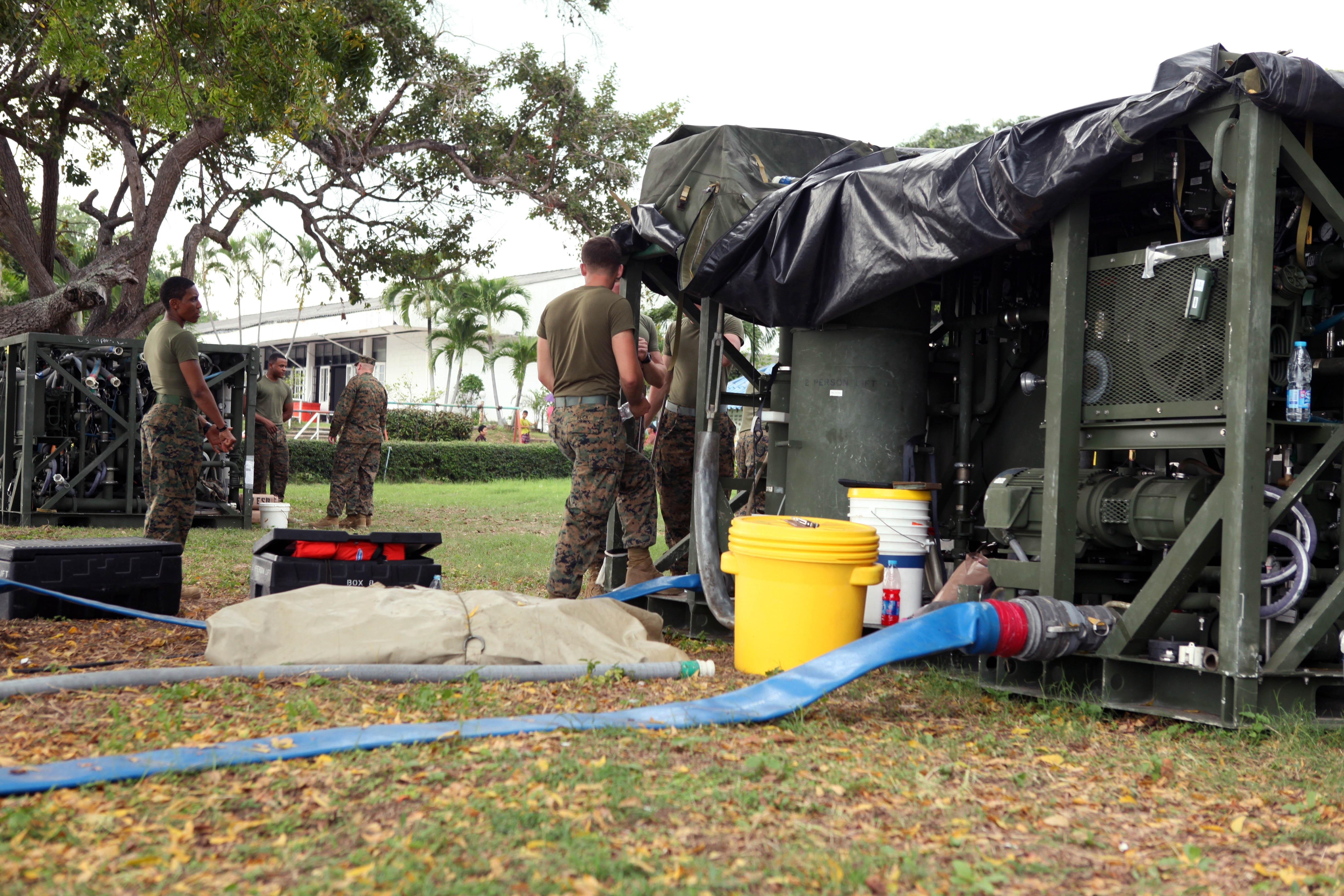 U.S. Marines from 3rd Marine Logistics Group operate a water purification system Feb. 10 in ...