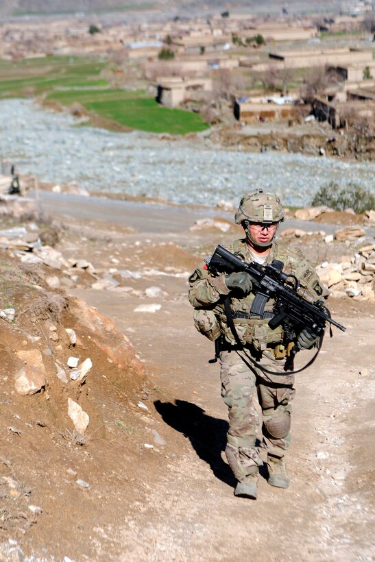 U.S. Army Spc. Hector Loo patrols a road to the Marawara District ...