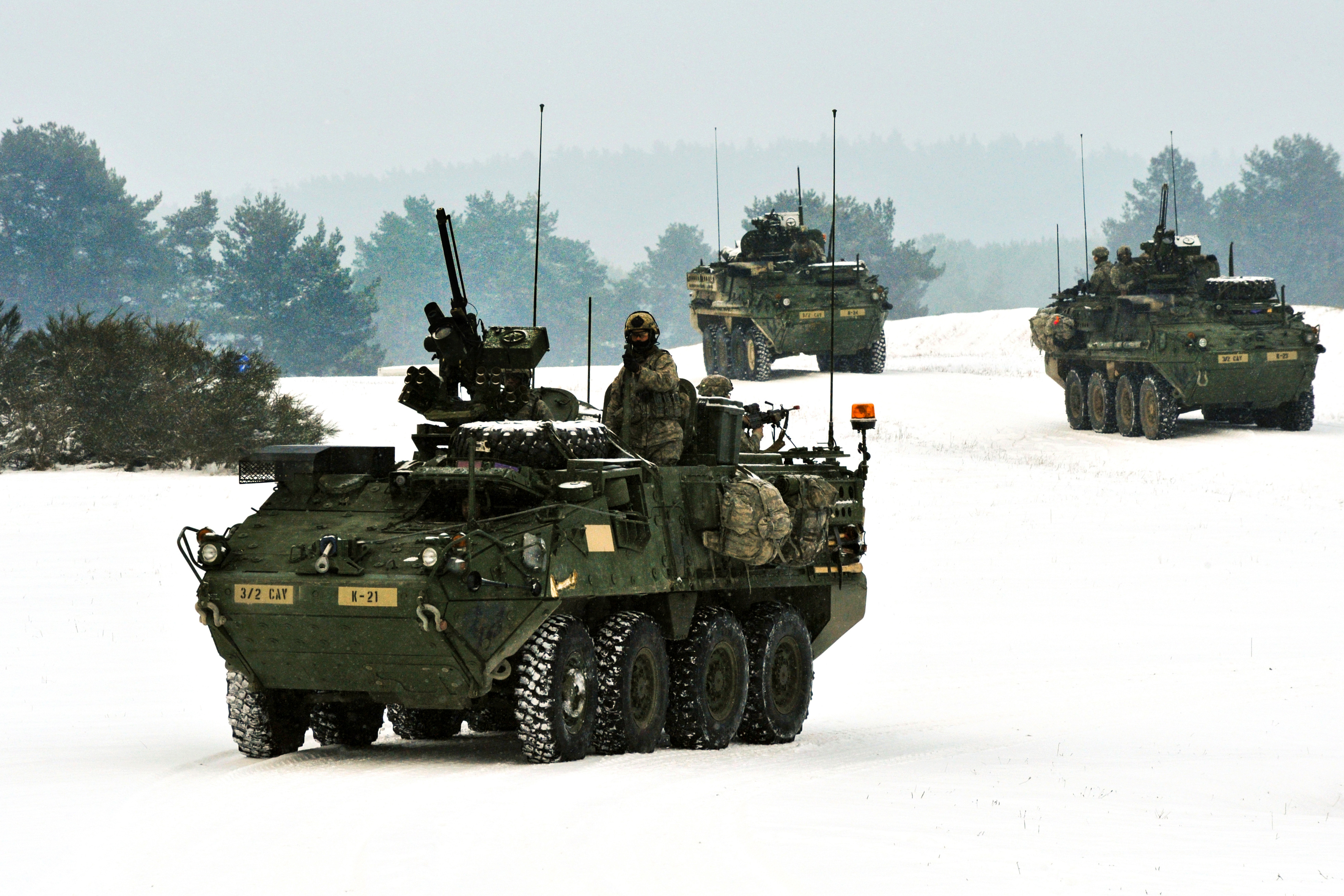 U.S. soldiers maneuver their Stryker vehicles through the snow during ...