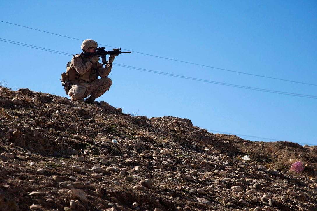 U.S. Marine Corps 1st Lt. William Kavanagh uses the optic lens on his ...