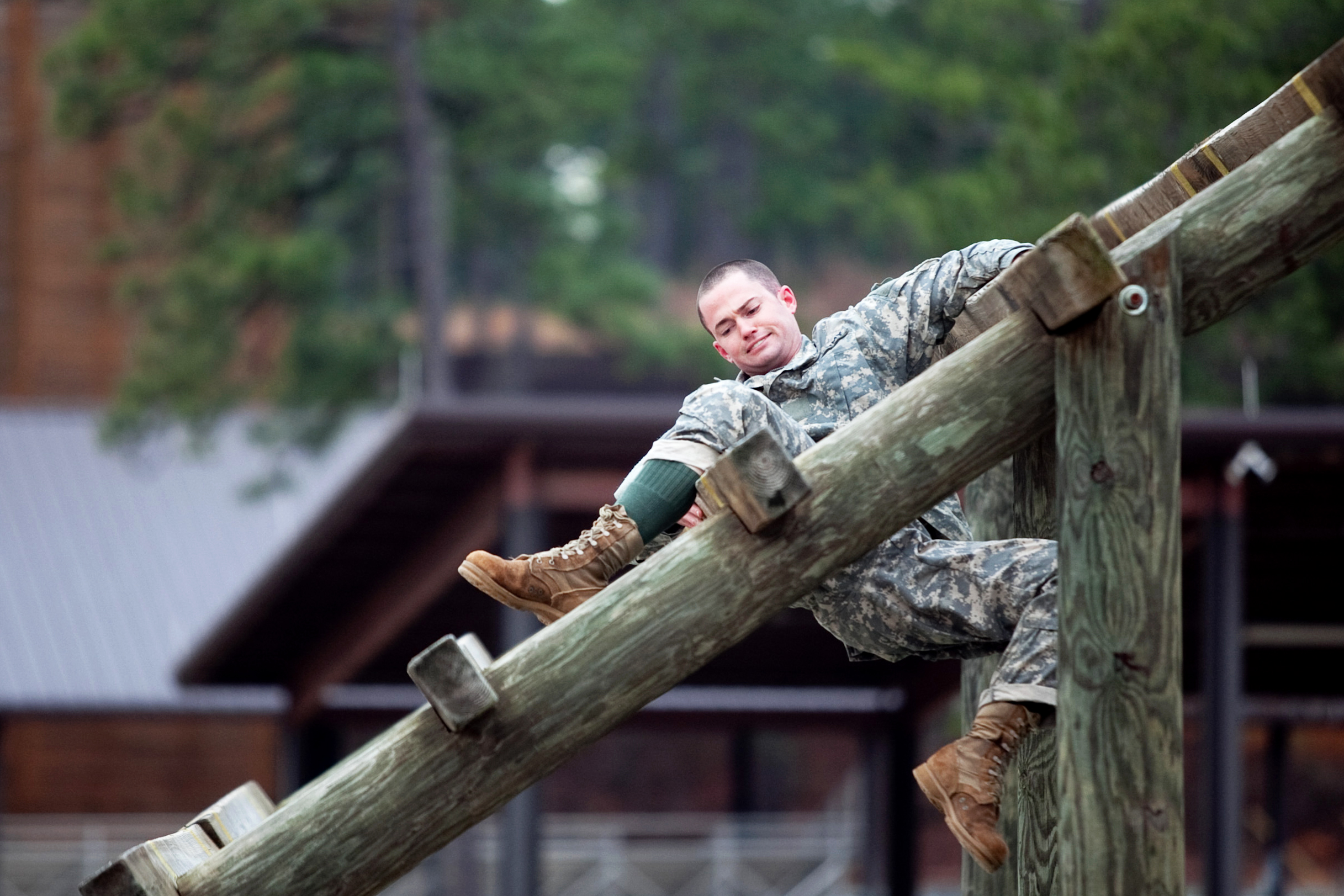 Army 2nd Lt. Mark McFeaters moves through an obstacle known as the ...
