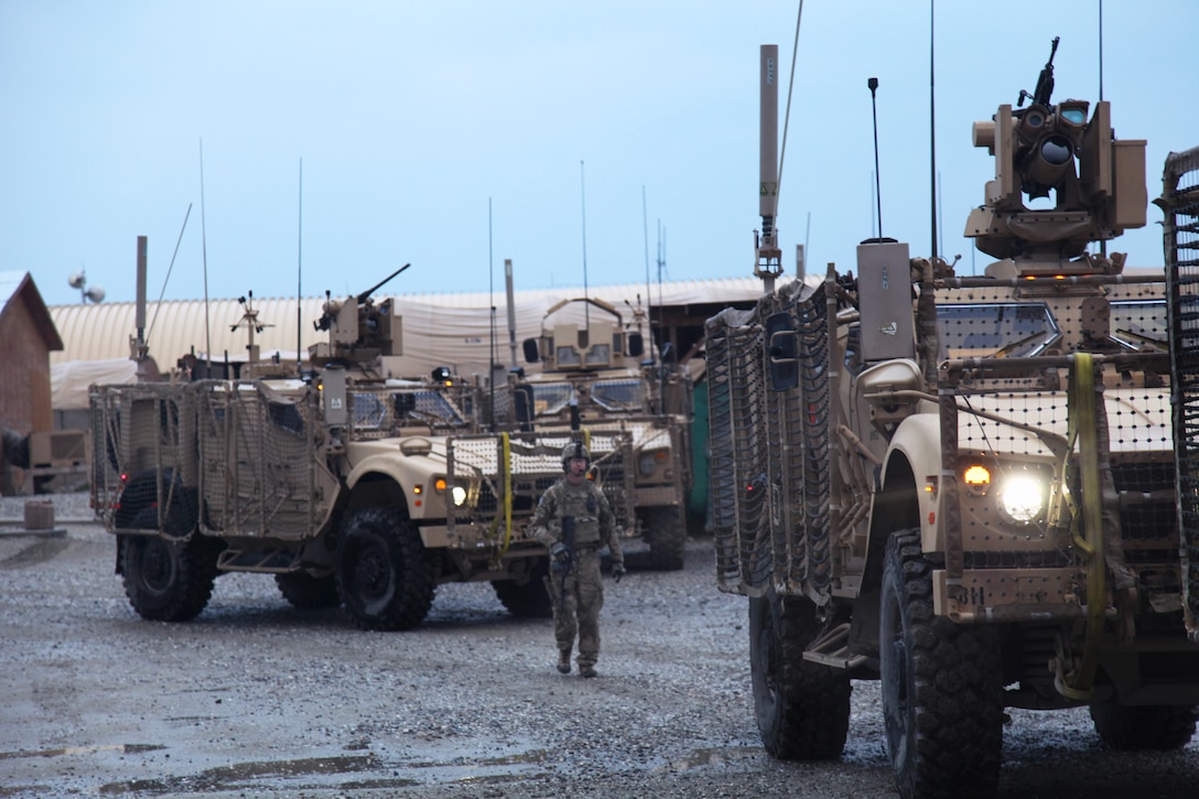 U.S. Army Sgt. Michael Tice ground guides a tacticle vehicle on Forward ...
