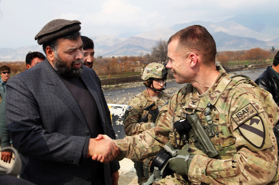 U.S. Army Col. William Benson shakes hands with the Laghman provincial ...