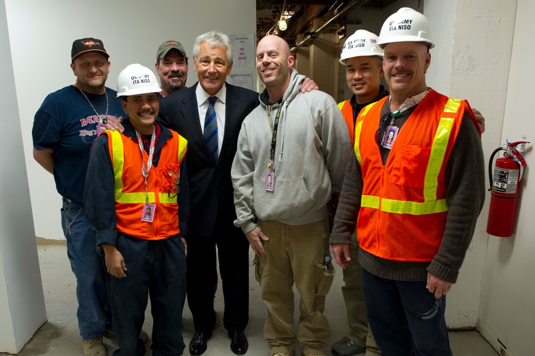New Defense Secretary Chuck Hagel stops and poses for photos with ...