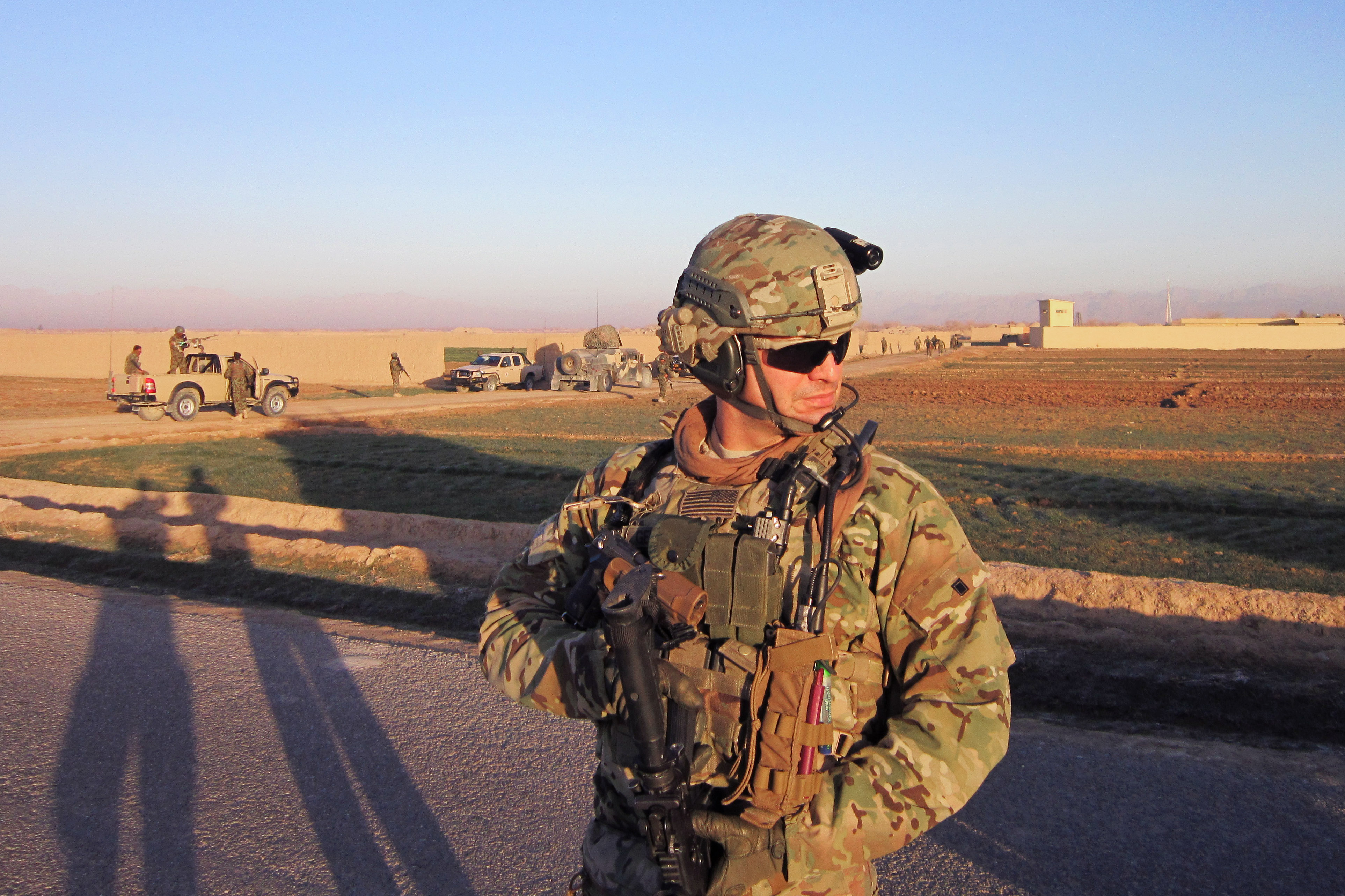 U.S. Army Capt. Jeremiah Gebhart provides security on a street outside ...