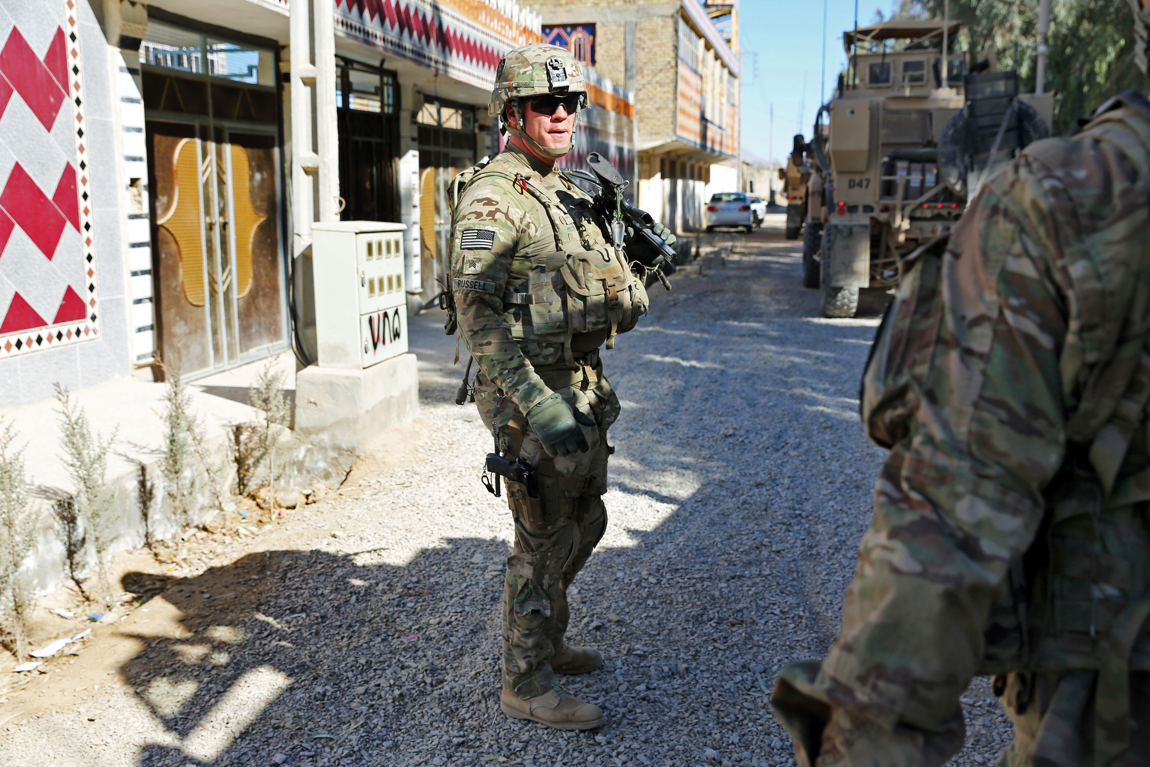 U.S. Army Sgt. William Russell checks security at the site of a ...