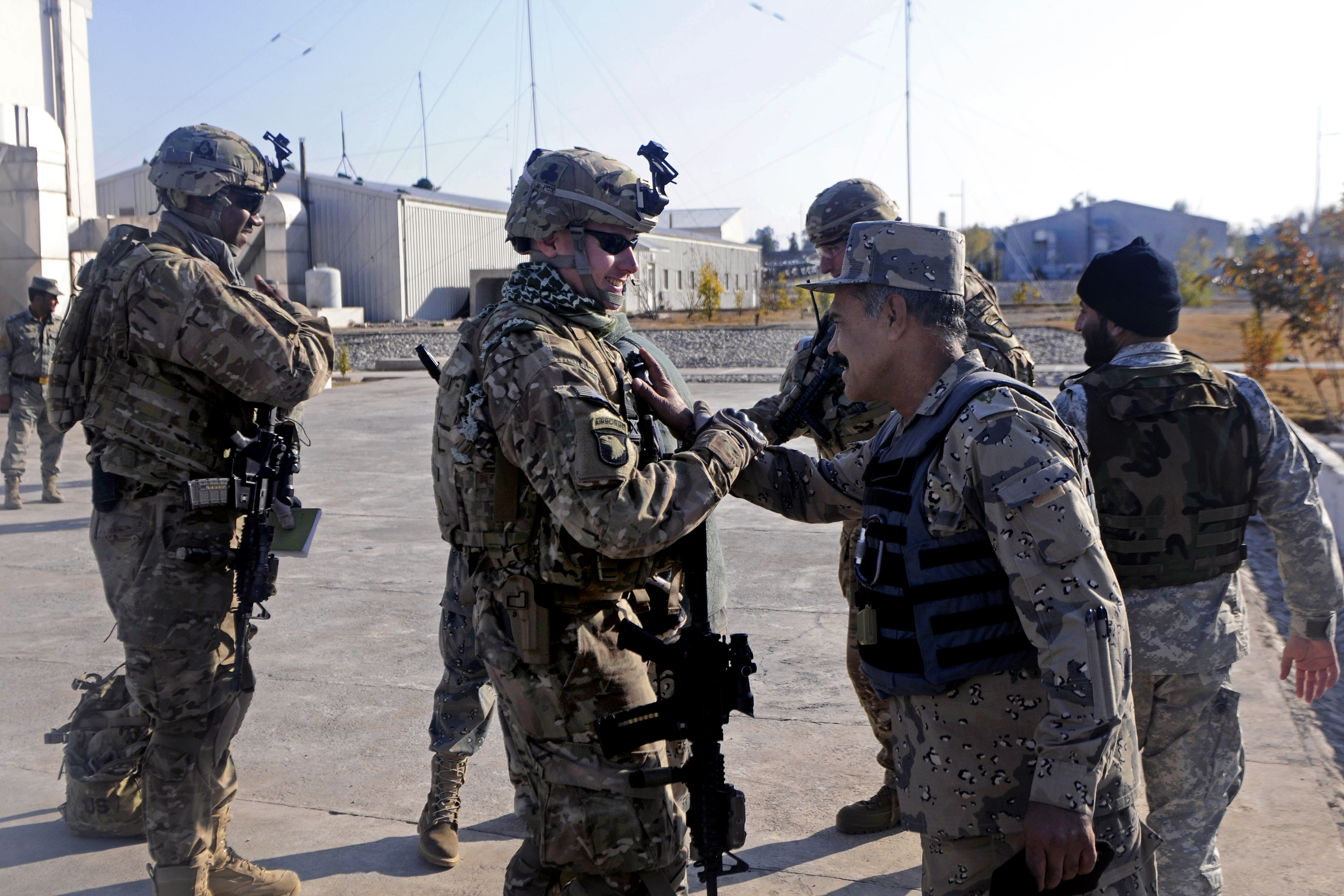 U.S. soldiers and Afghan border police shake hands on Combat Outpost ...