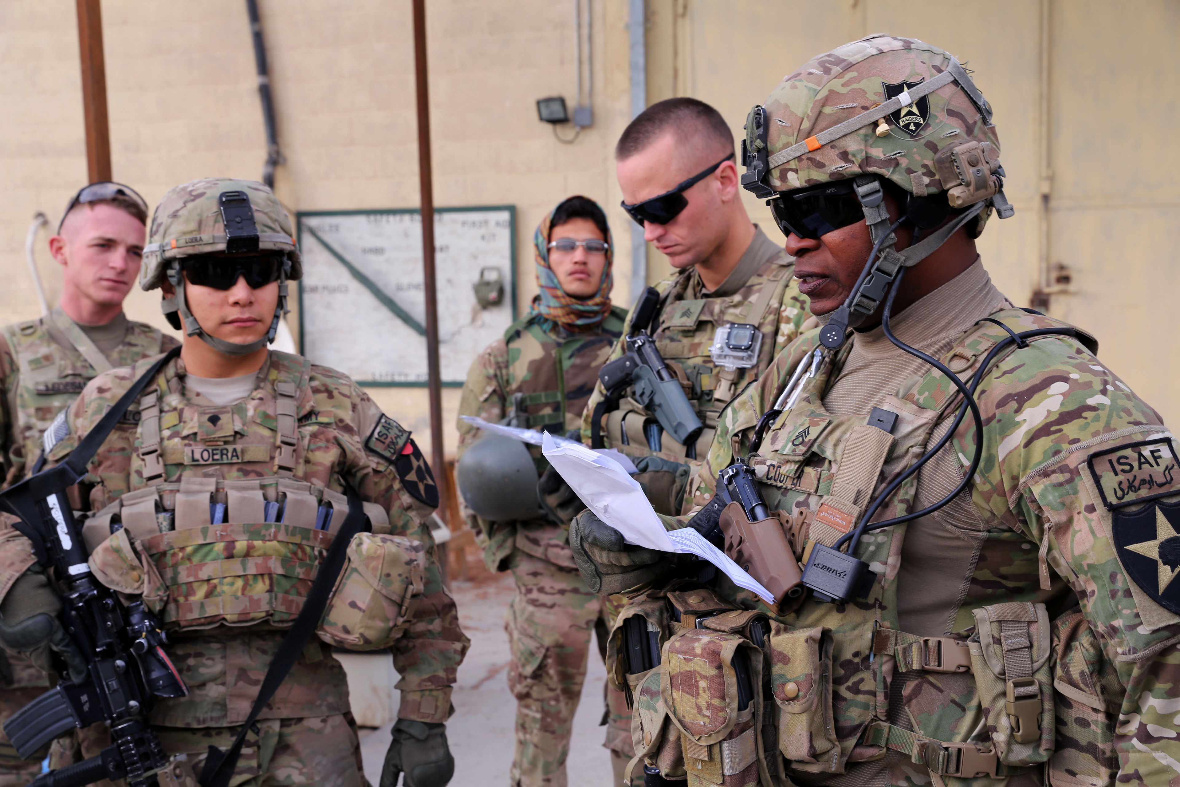 U.S. Army Staff Sgt. Roderick Cooper, right, conducts a mission ...