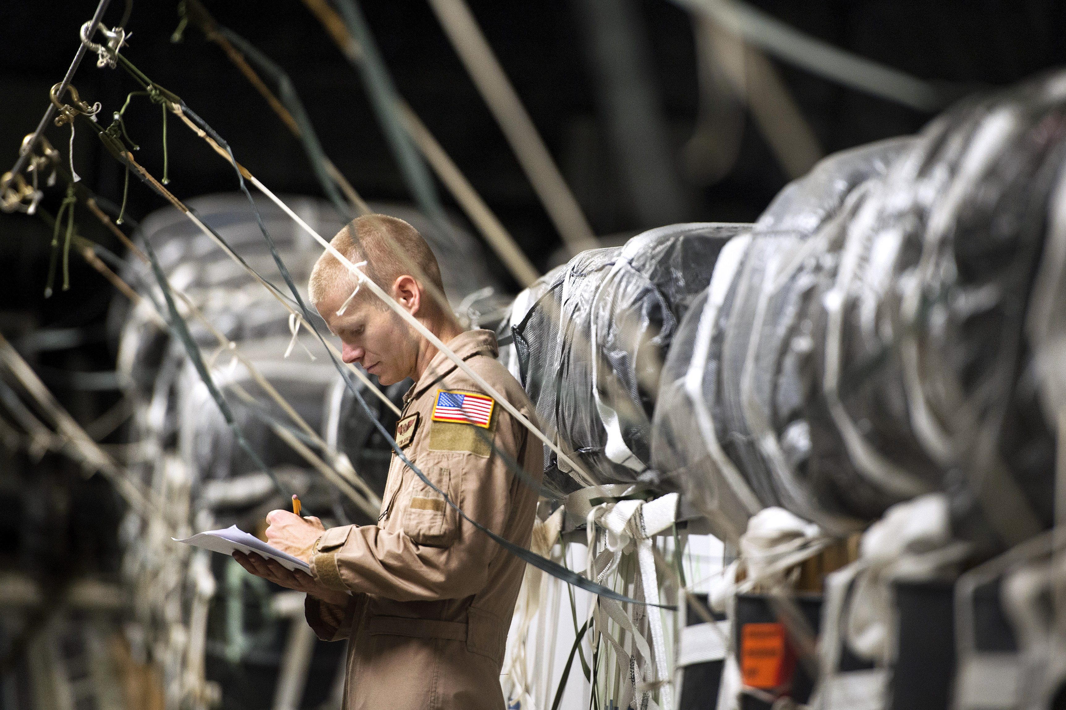 U.S. Air Force Staff Sgt. Tim Jaskot inspects the weight and balance ...