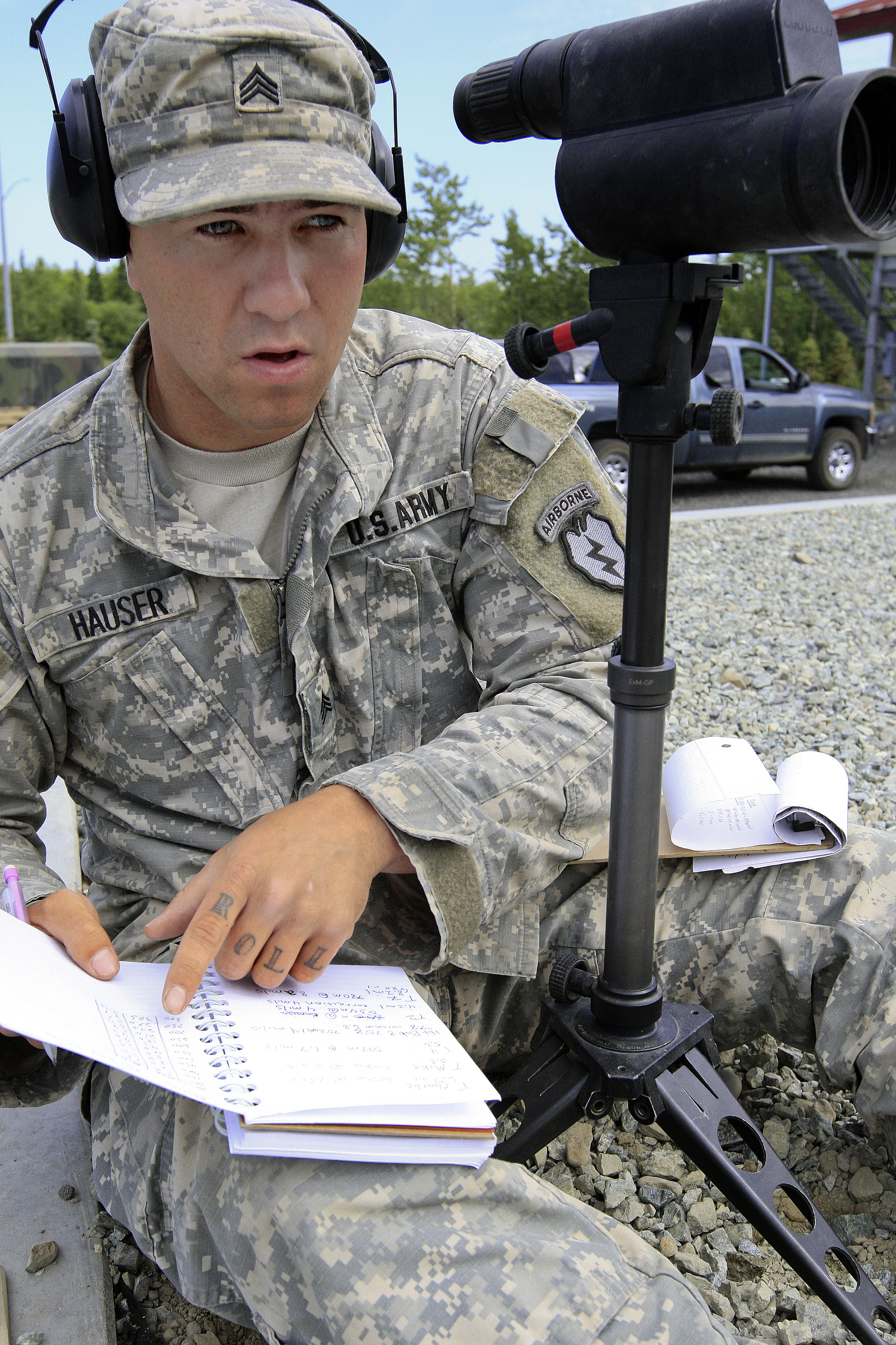 Army Sgt. Vincent Hauser references his notes while giving aiming ...