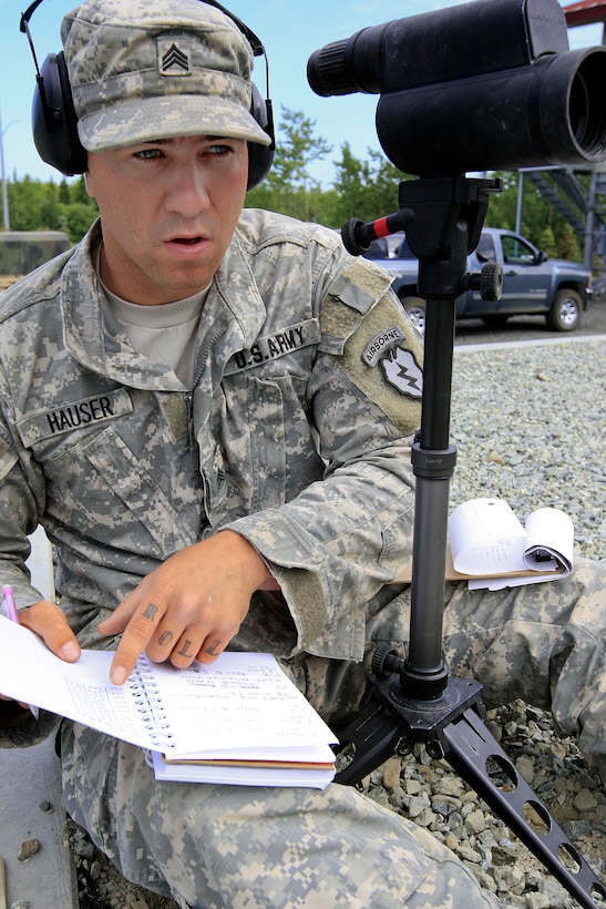 Army Sgt. Vincent Hauser references his notes while giving aiming ...