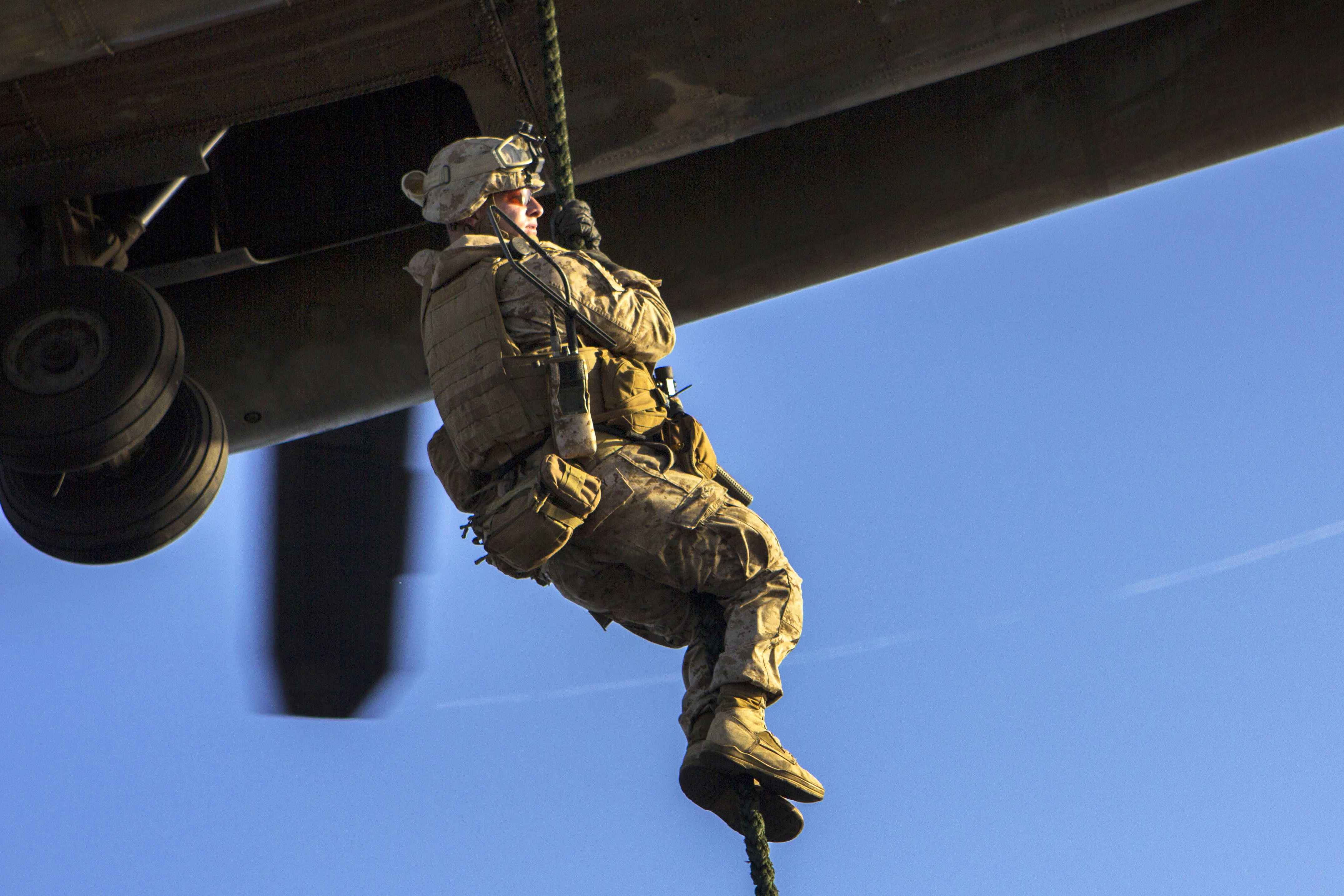 A U.S. Marine fast ropes from a CH-53 Super Stallion helicopter during ...