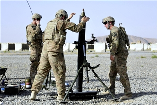 Army mortar men fire a 120mm mortar during force protection and ...