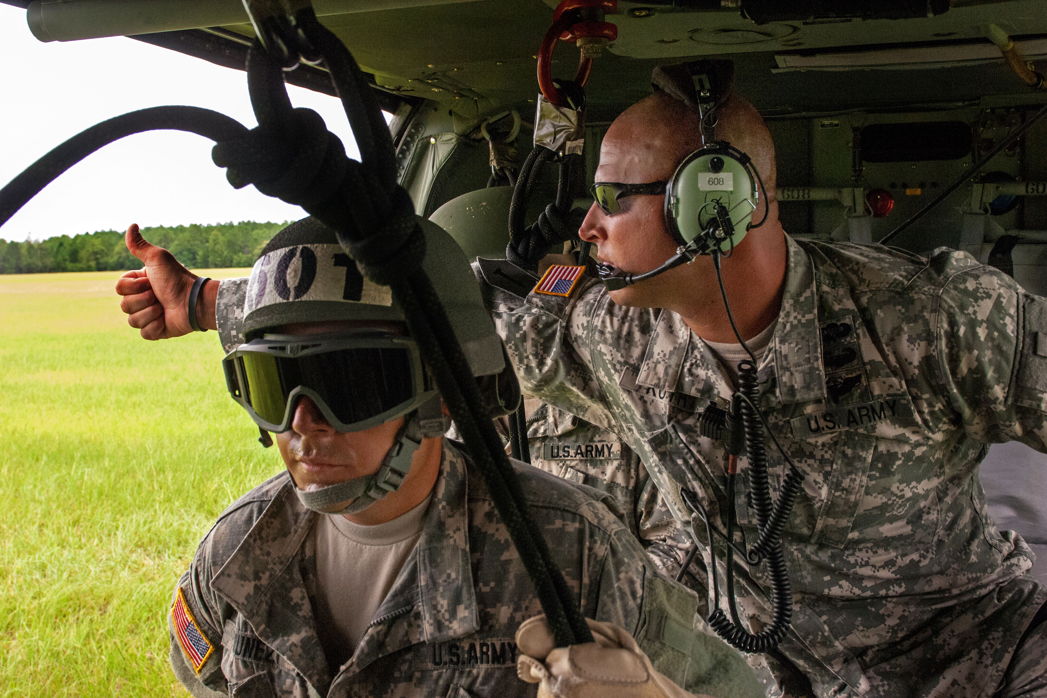 An Army instructor gives the sign that his team is ready to rappel from ...