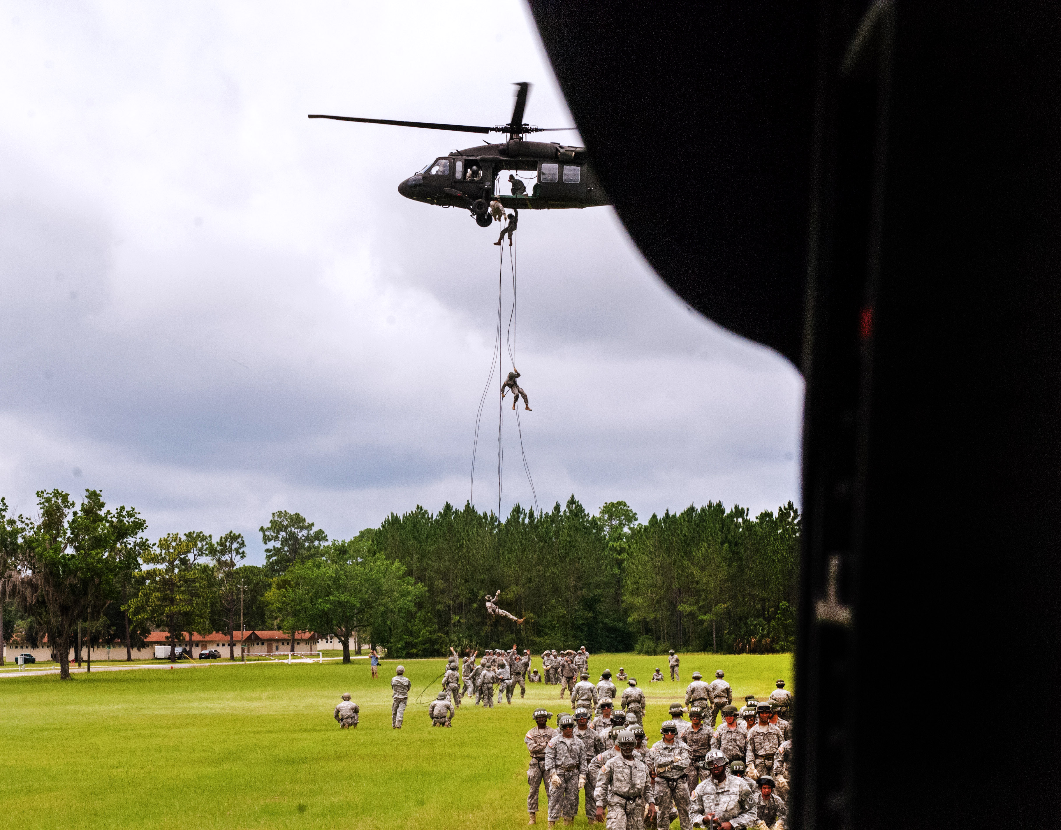 Air assault students rappel from a UH-60 Black Hawk helicopter on Camp ...