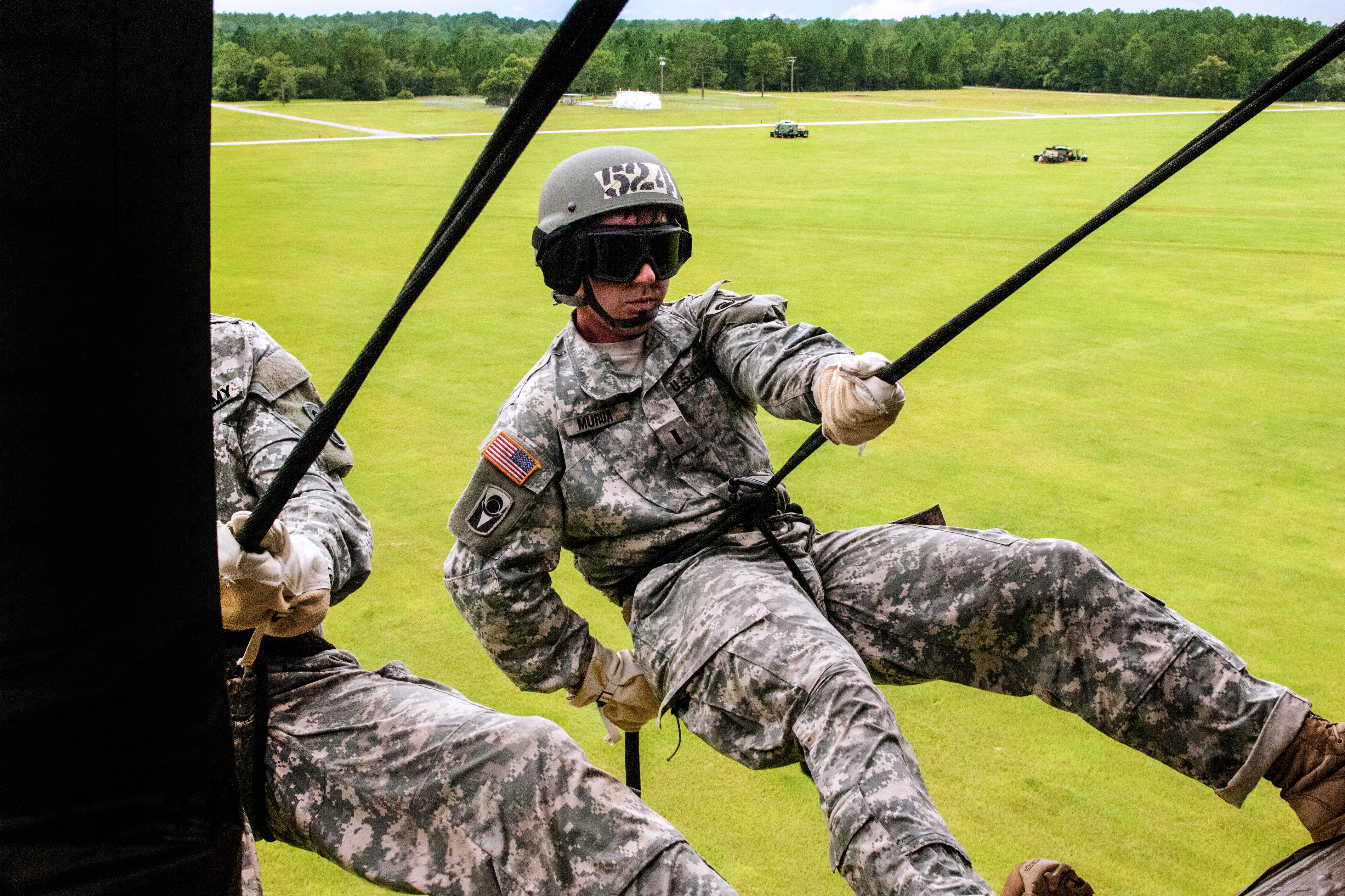Army 1st Lt. Stephen Murga, right, rappels 70 feet from a UH-60 Black ...