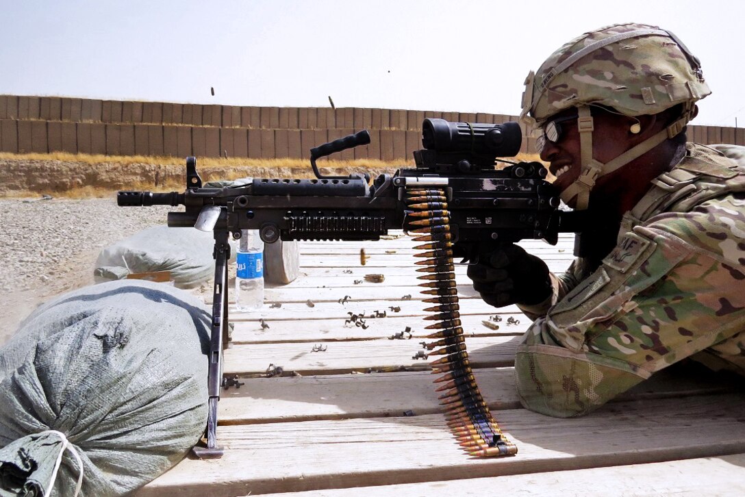 U.S. Army Spc. Miles Owens fires the M249 machine gun at a range during training in Kunduz ...