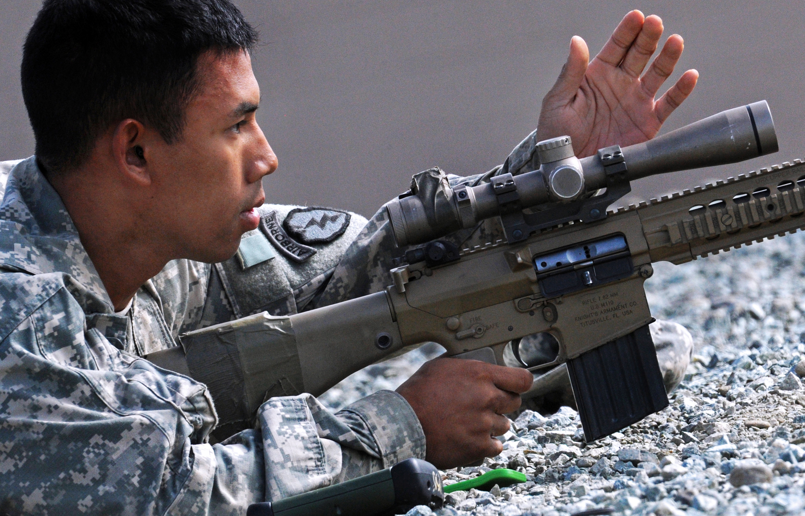 Army Spc. Steve Le makes a correction to his scope during the final day ...